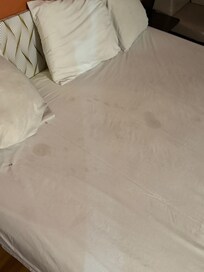 stains and cigarette burns on the sheets
