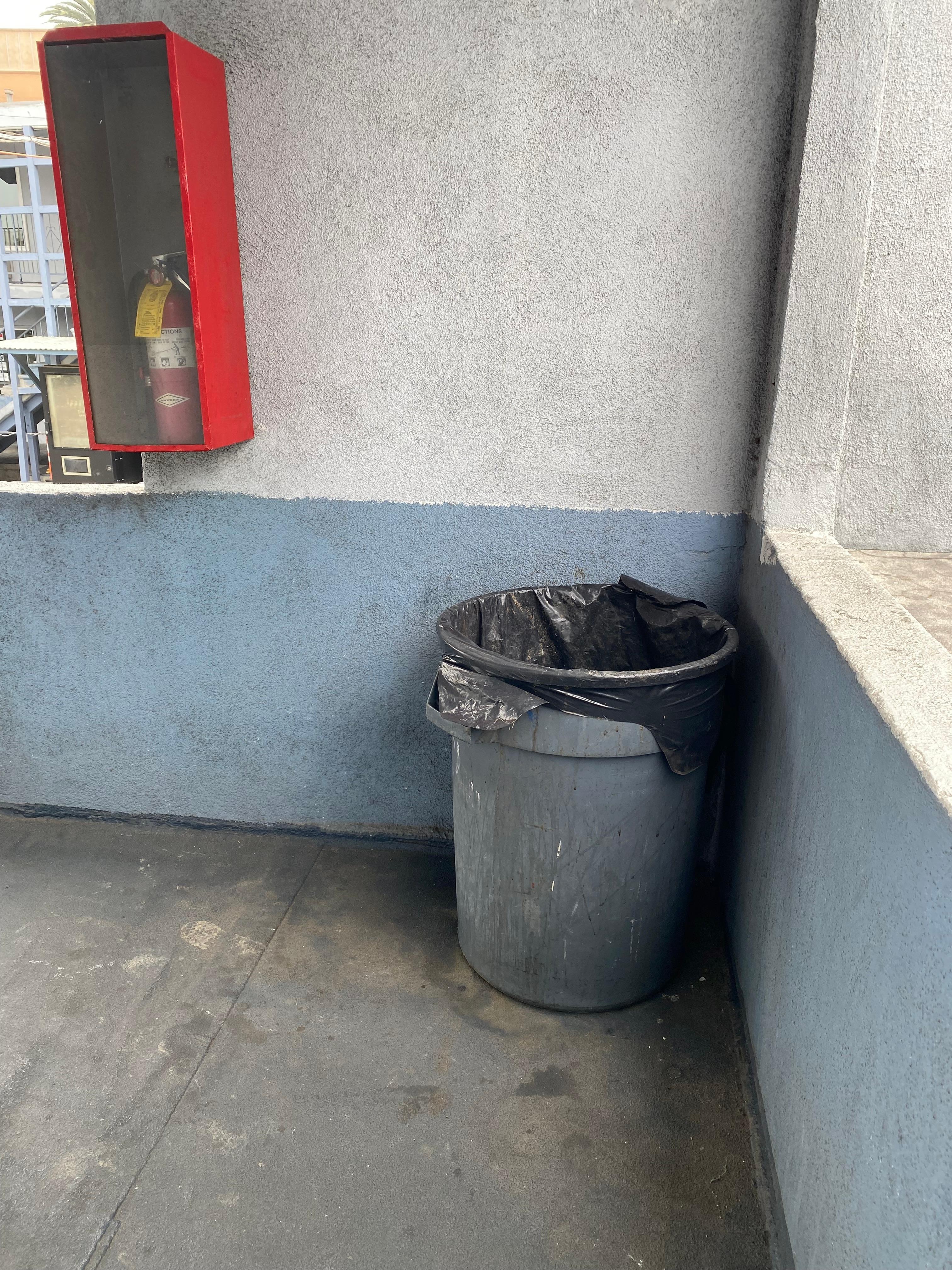 Neglected trash bin right outside the door