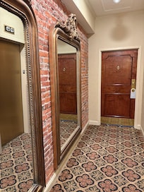Love the brick walls and big mirrors in the hallway
