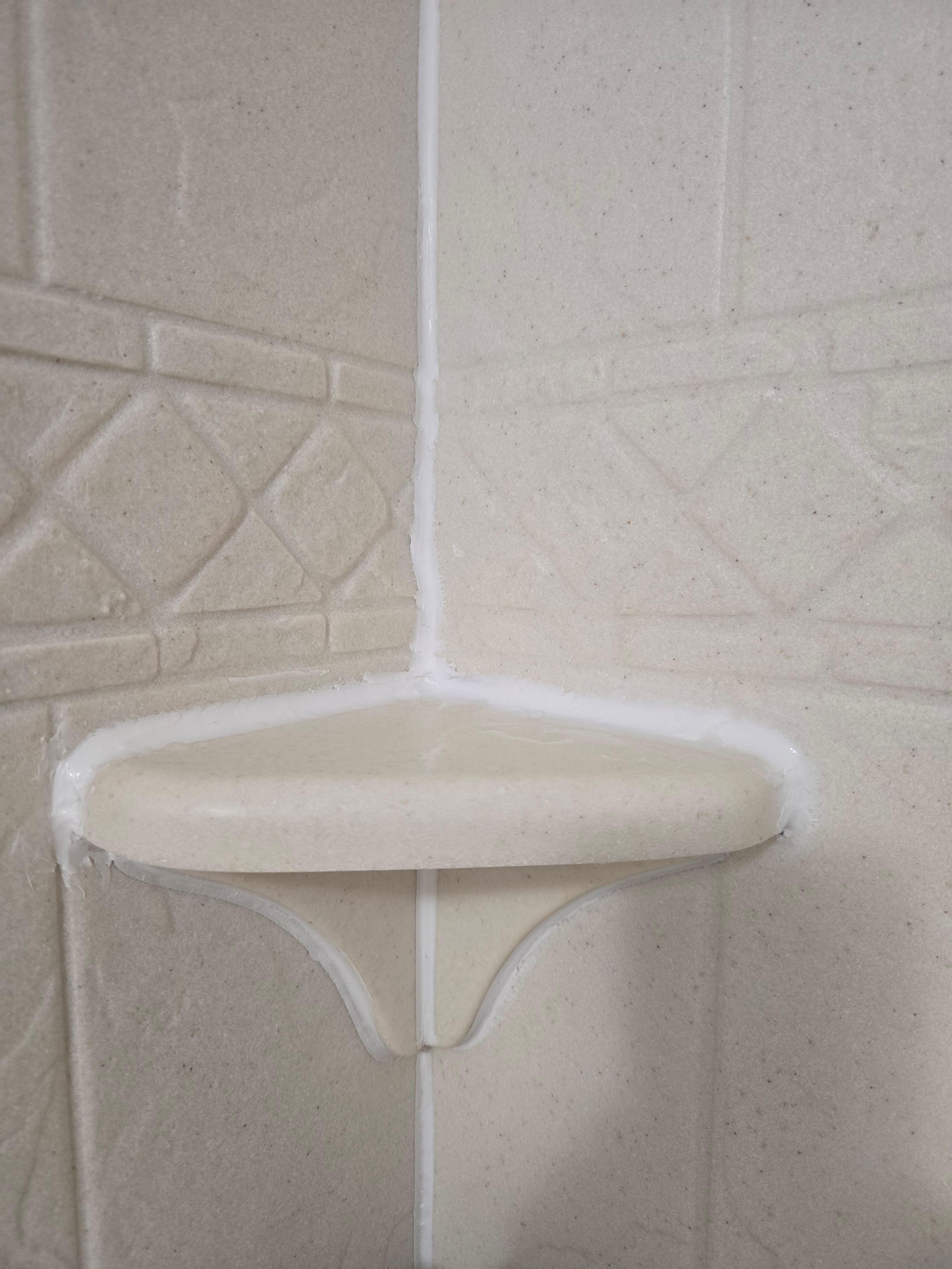 More caulk to try to cover mold