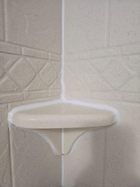 More caulk to try to cover mold