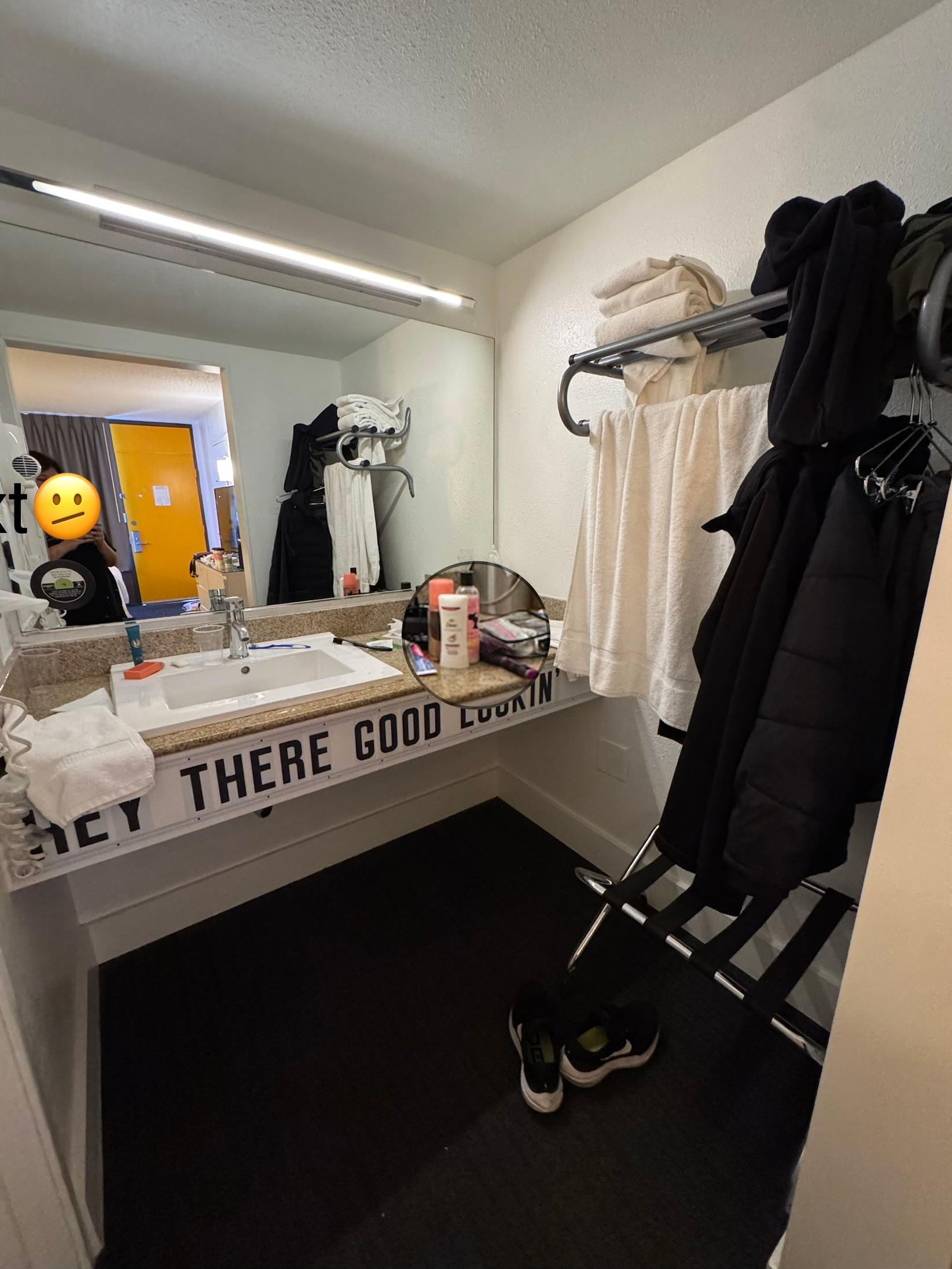 A view of the small bathroom vanity and only “makeshift closet”.
