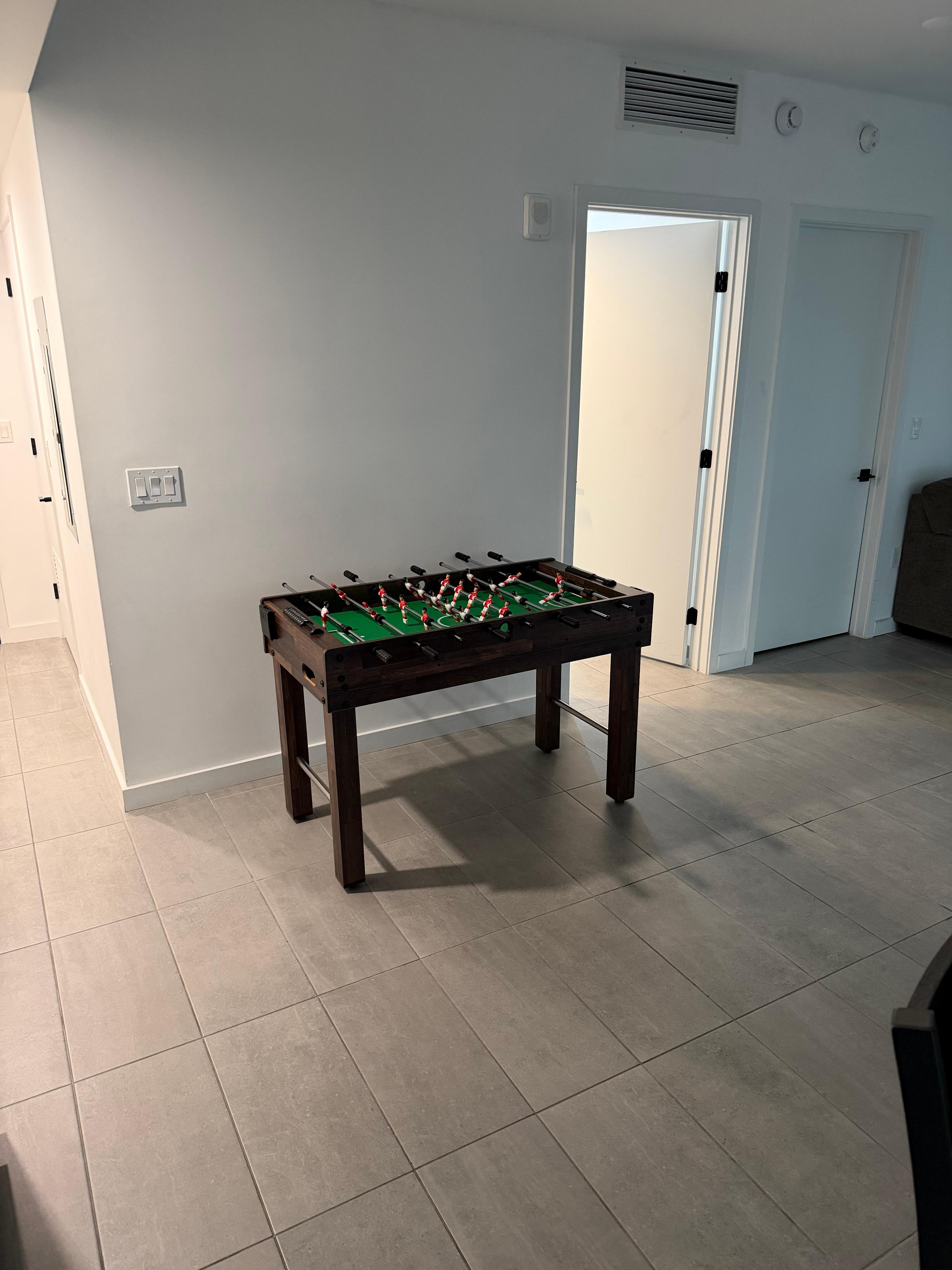 The lone bit of "personality". A cheap Foosball table that doesn't fit well in the space, makes no sense and looks like it was garbage picked.