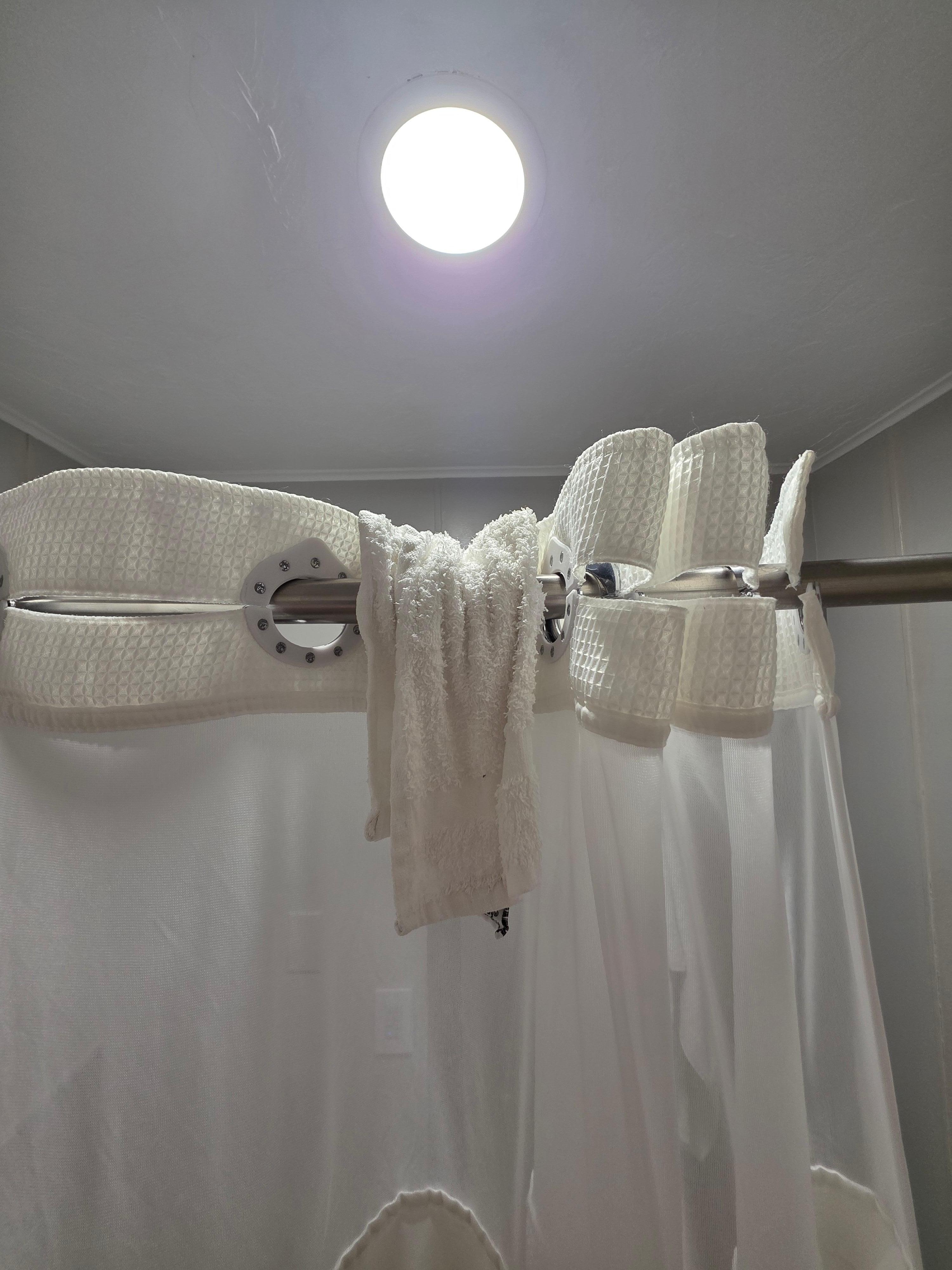 Dirty towel left on shower curtain