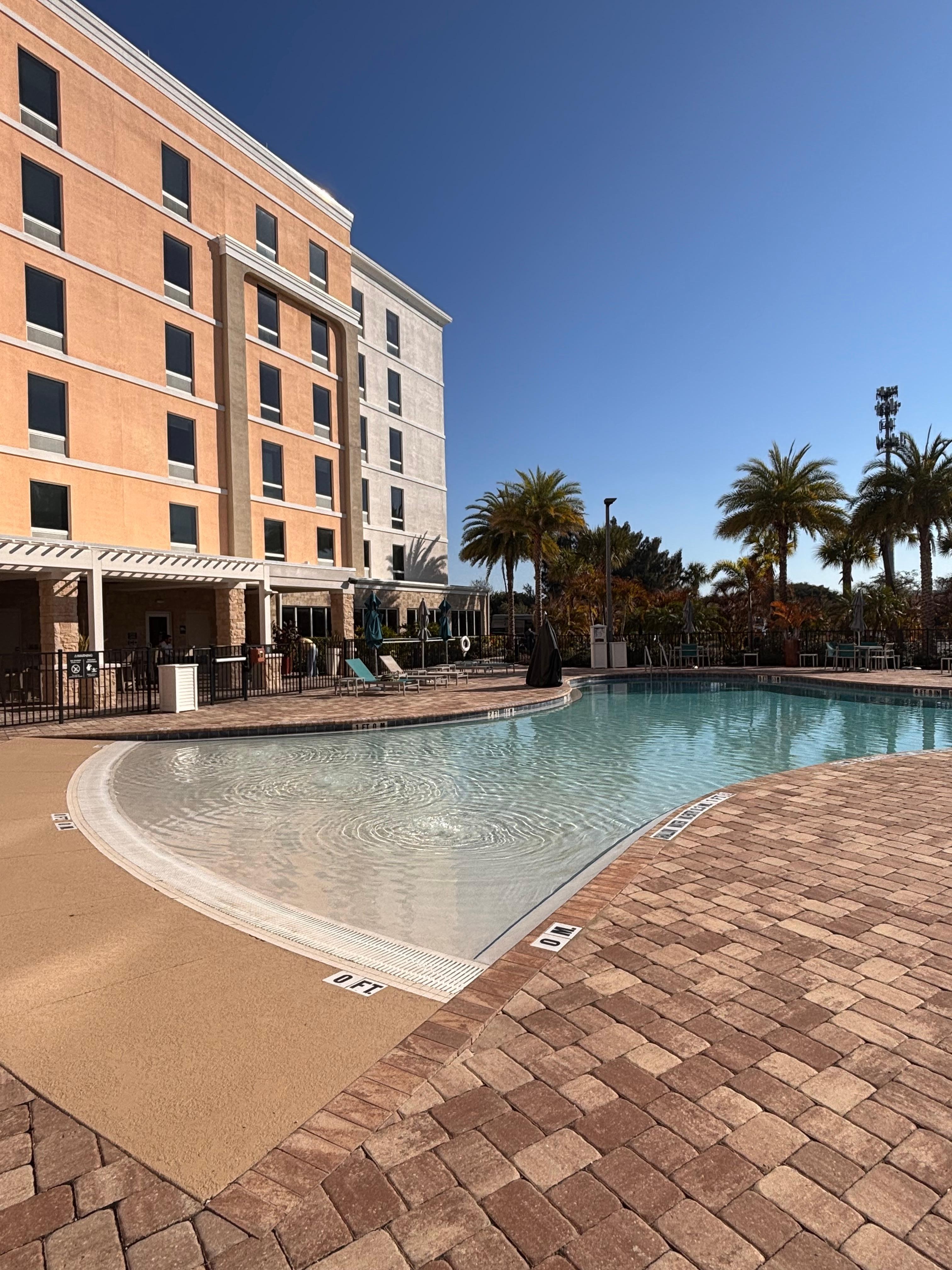 Pool area that has a bar.