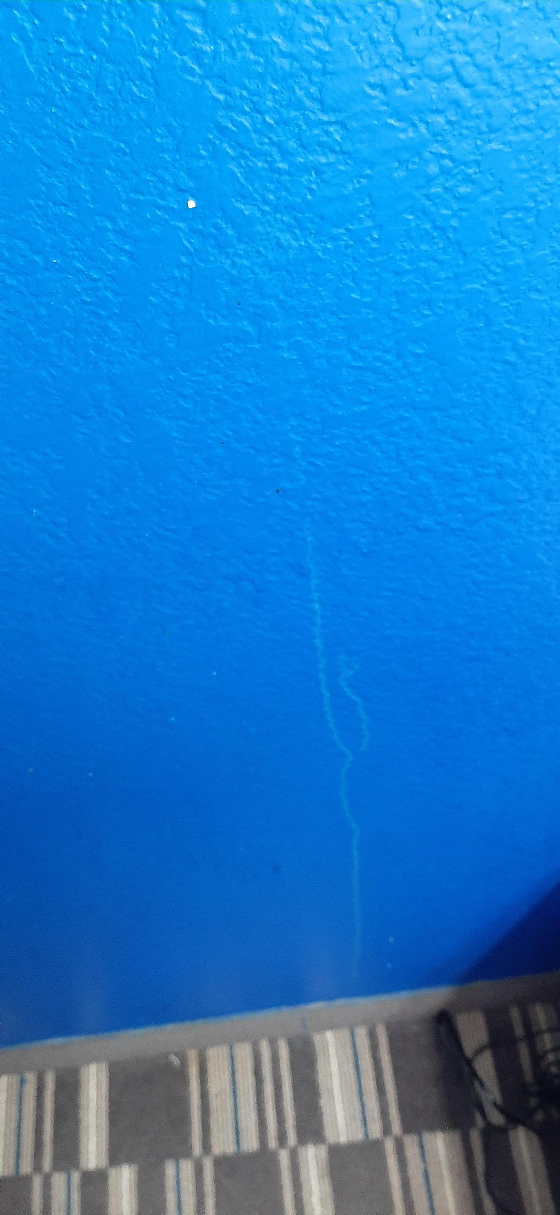 Probably urine stains on wall.