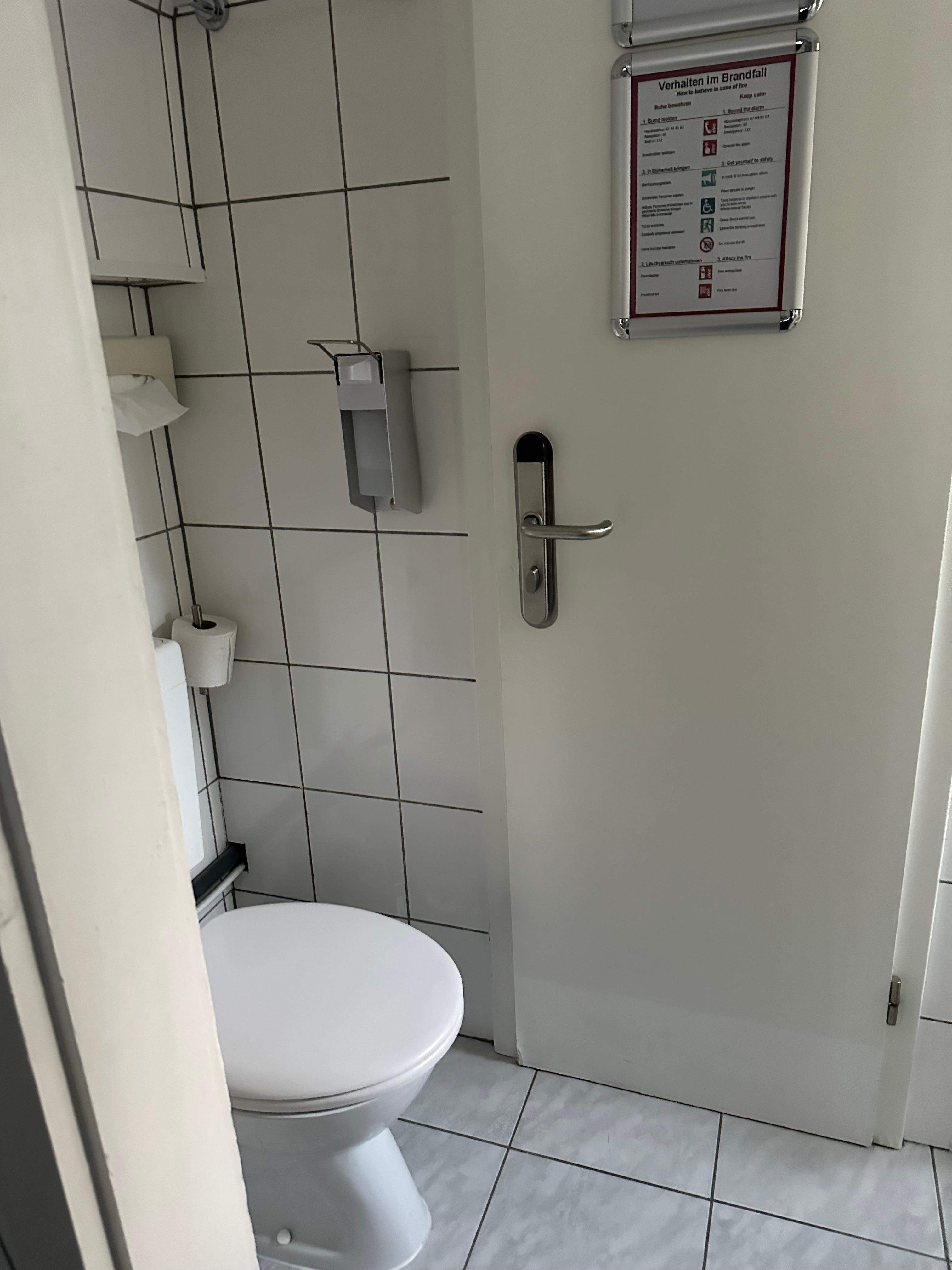 The room entrance door colliding with the toilet