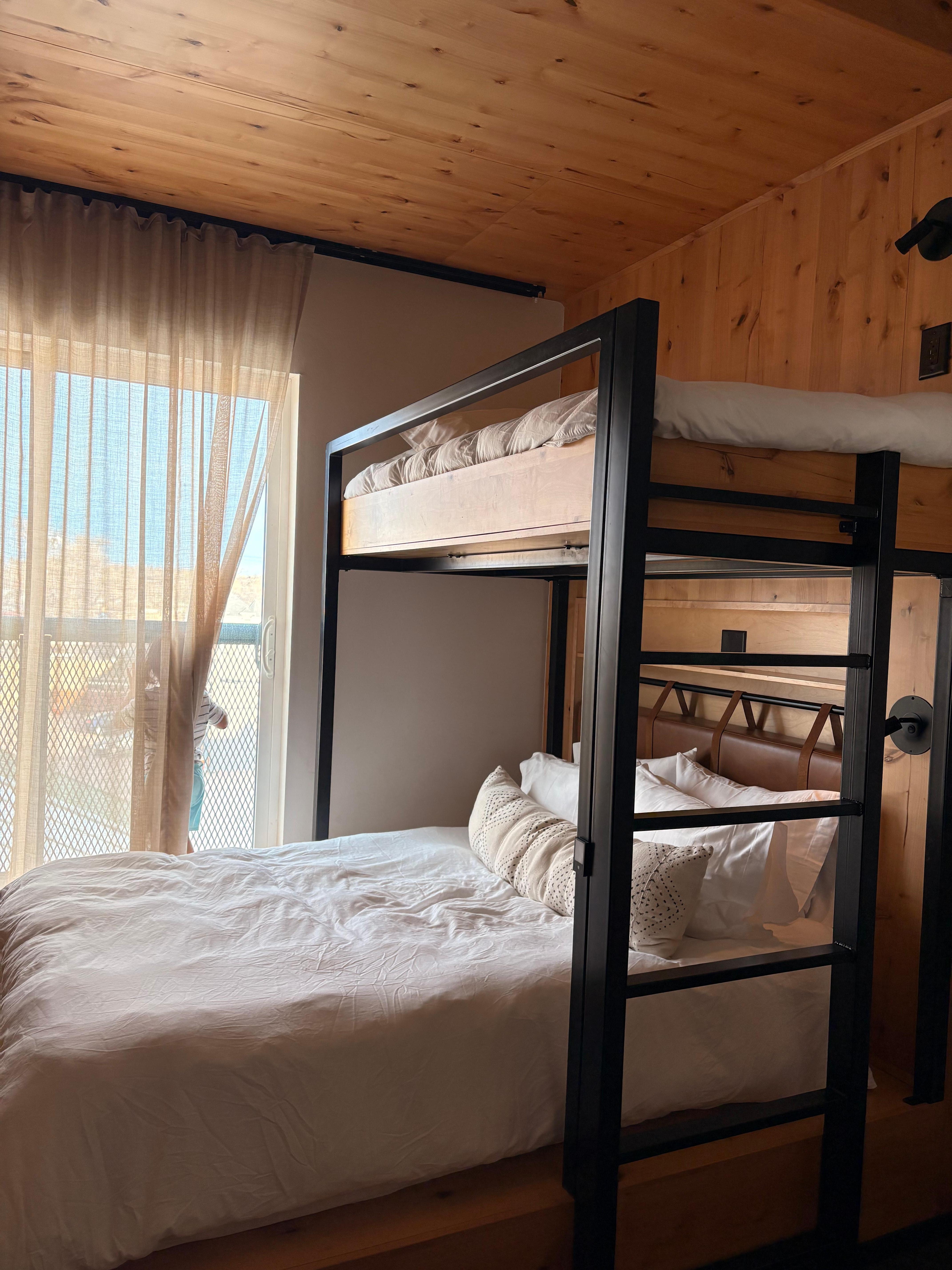 The bed area . The top bunk was comfy and cozy .