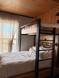 The bed area . The top bunk was comfy and cozy .