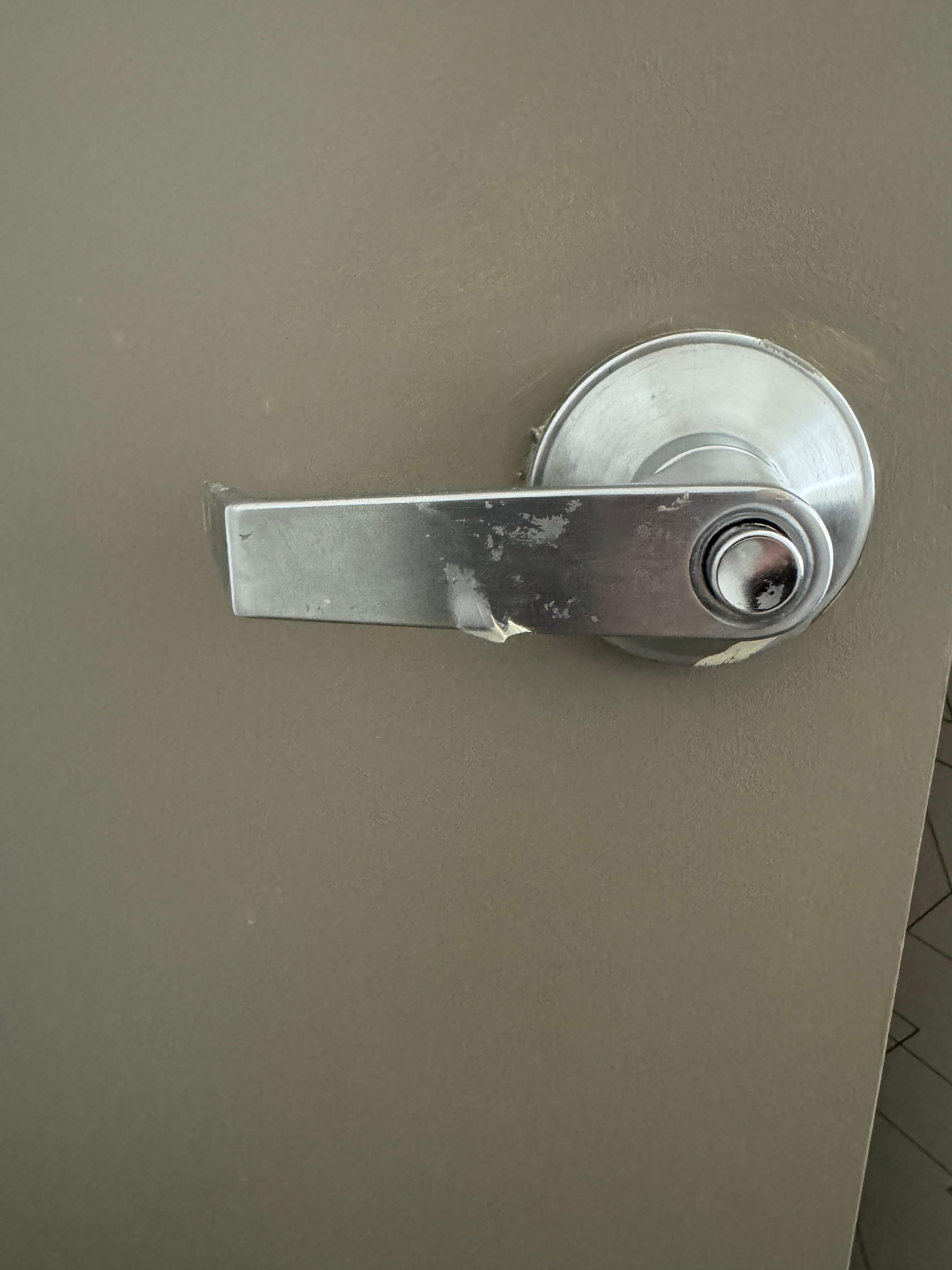 Caulk under & behind bathroom door handle
