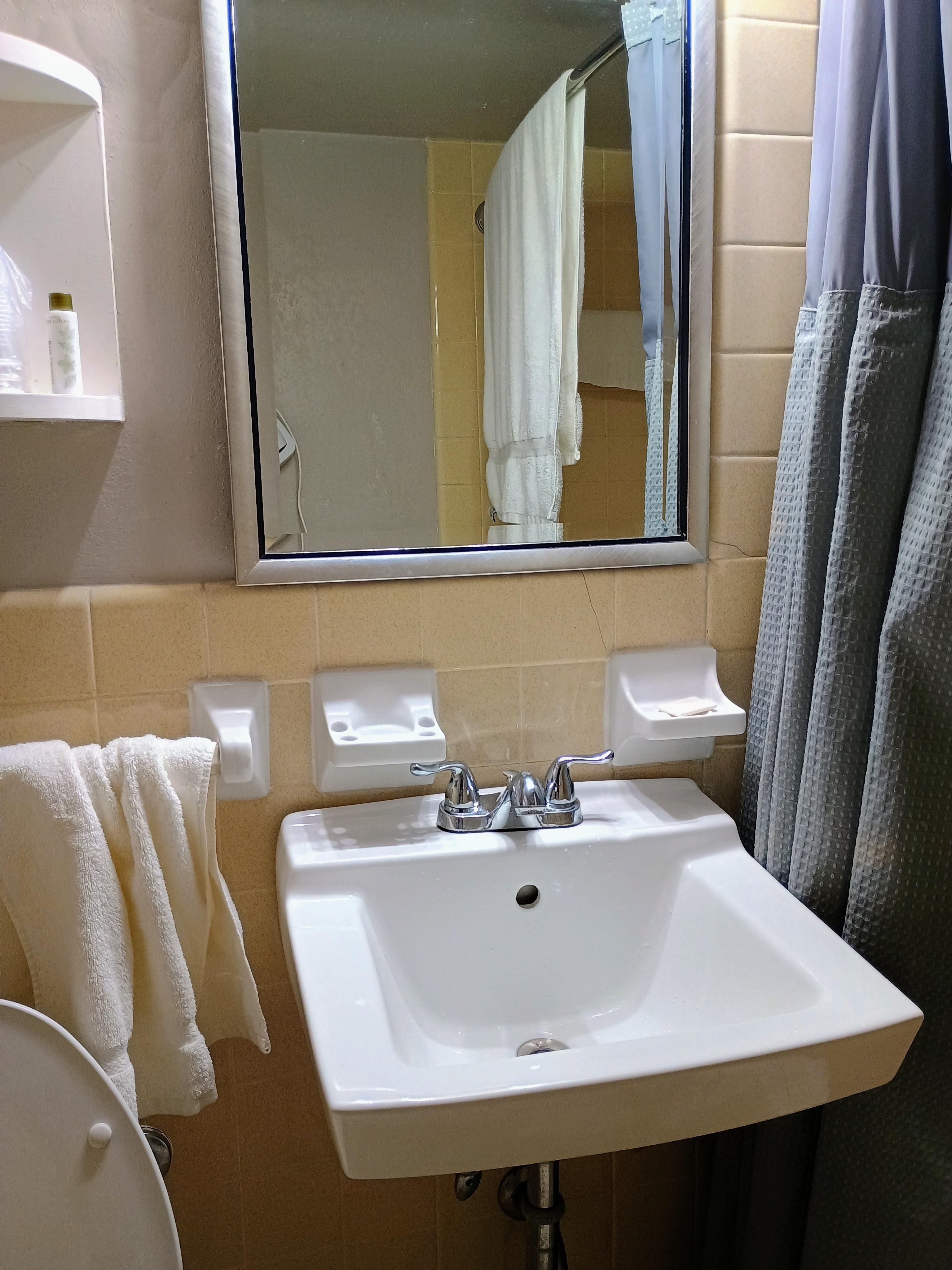 No room on the sink. Can't even turn the hot water on because the faucet is under this stupid toothbrush holder.