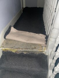 One of the trip hazard carpets in hallway outside room 3.