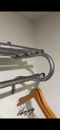 Clothes hanging rack very loose and swaying, about to fall off wall. Very poor condition. Room #222.
