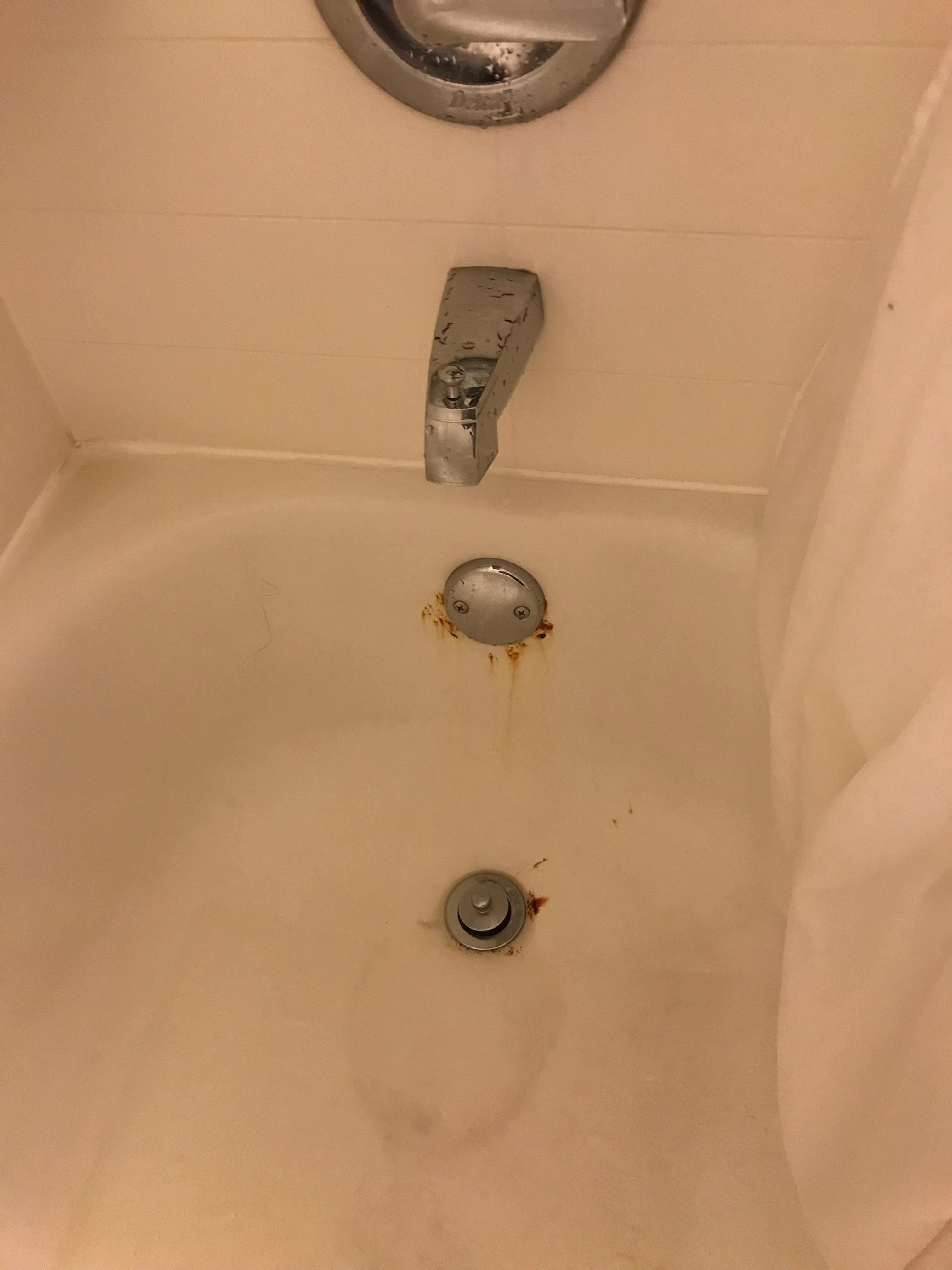 Rust around bathtub faucet (so gross)