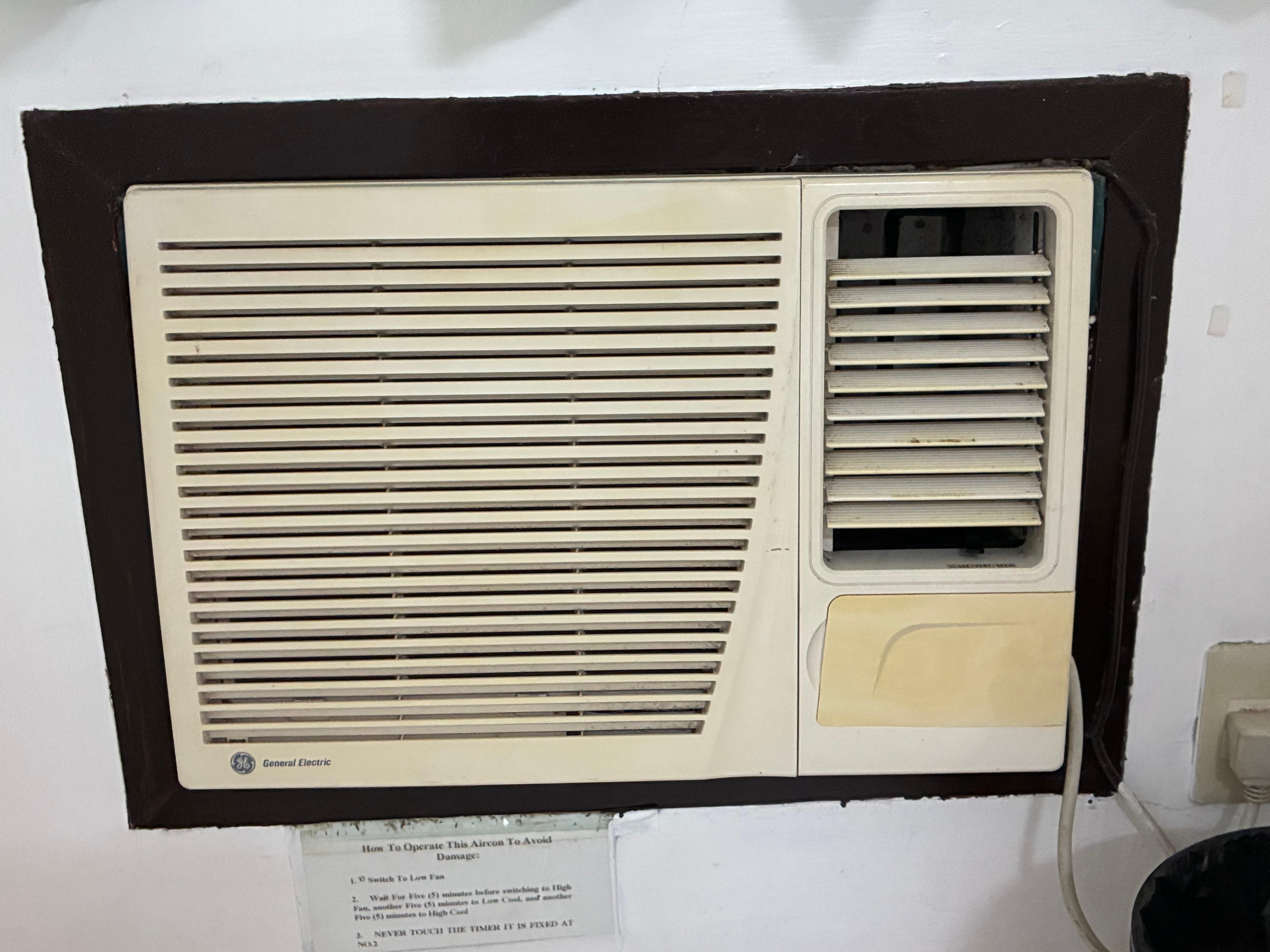 Old air conditioner noisy and not working properly as the room was still hot