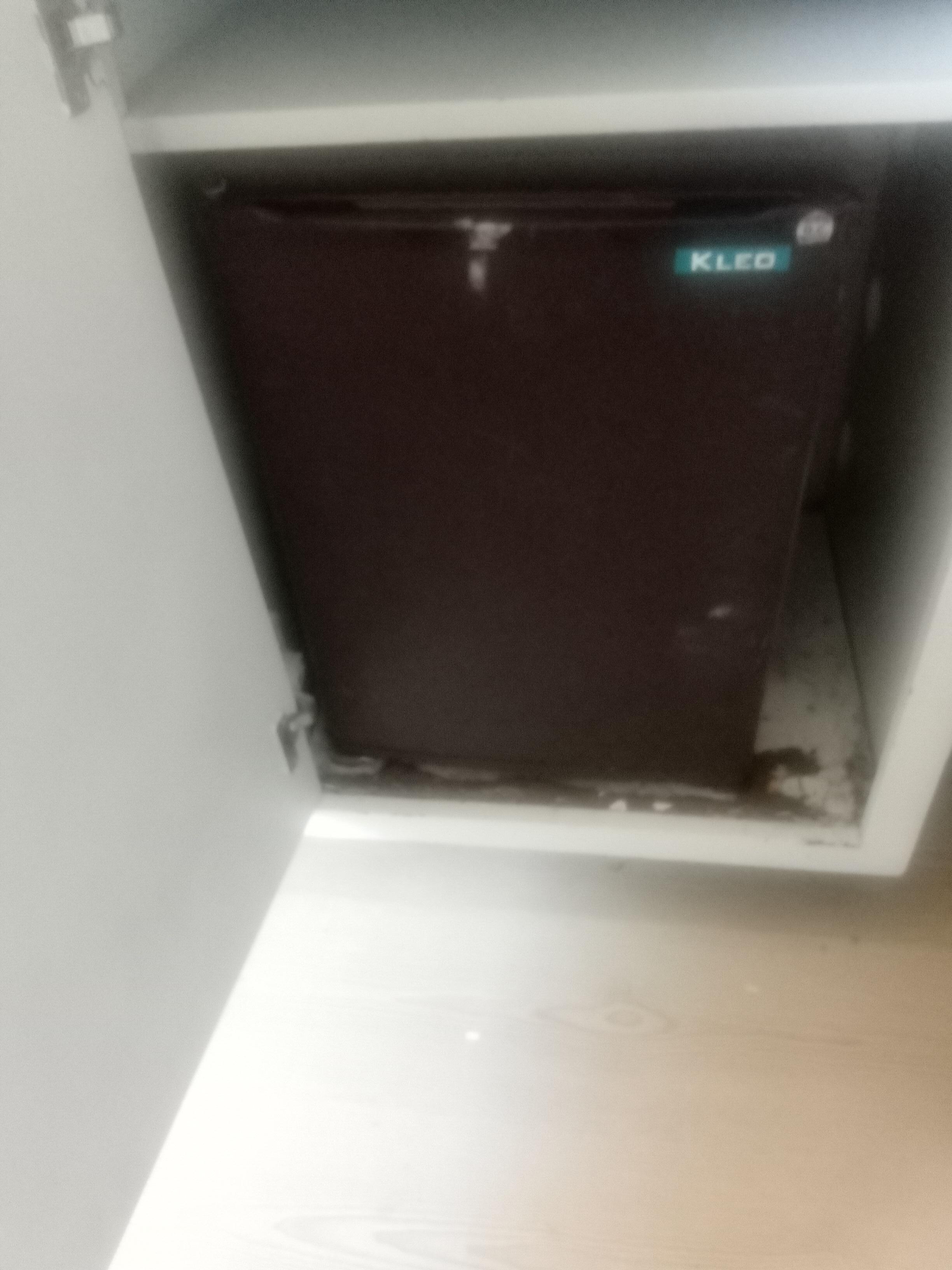 Leaking broken fridge with door falling off