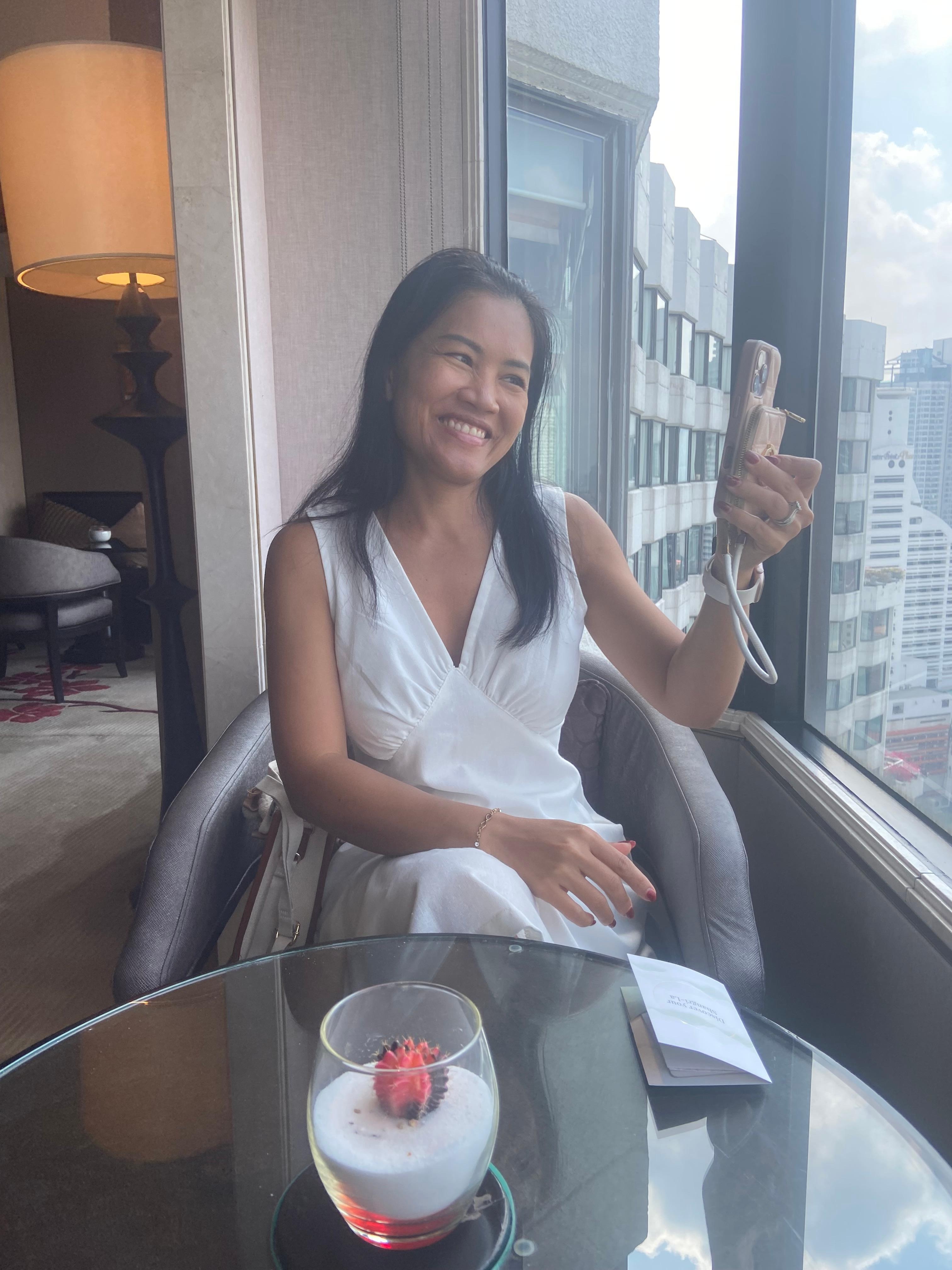 Meme having coffee looking down at the beautiful pool