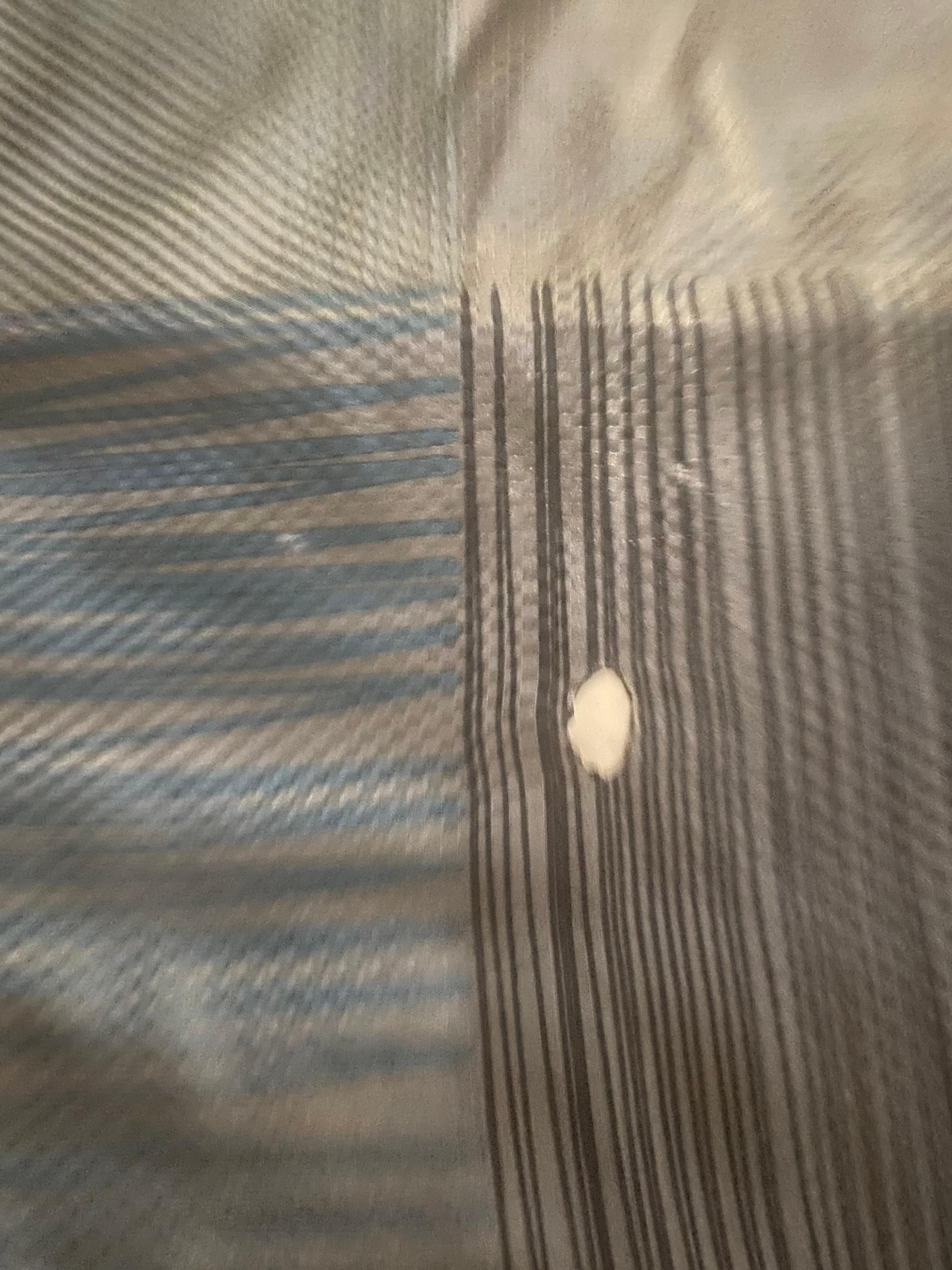 Cigarette burns in bedding. 