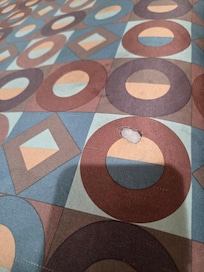 Cigarette burns on the bed cover 😑