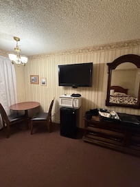 Sitting area, microwave, mini fridge, TV, & dresser