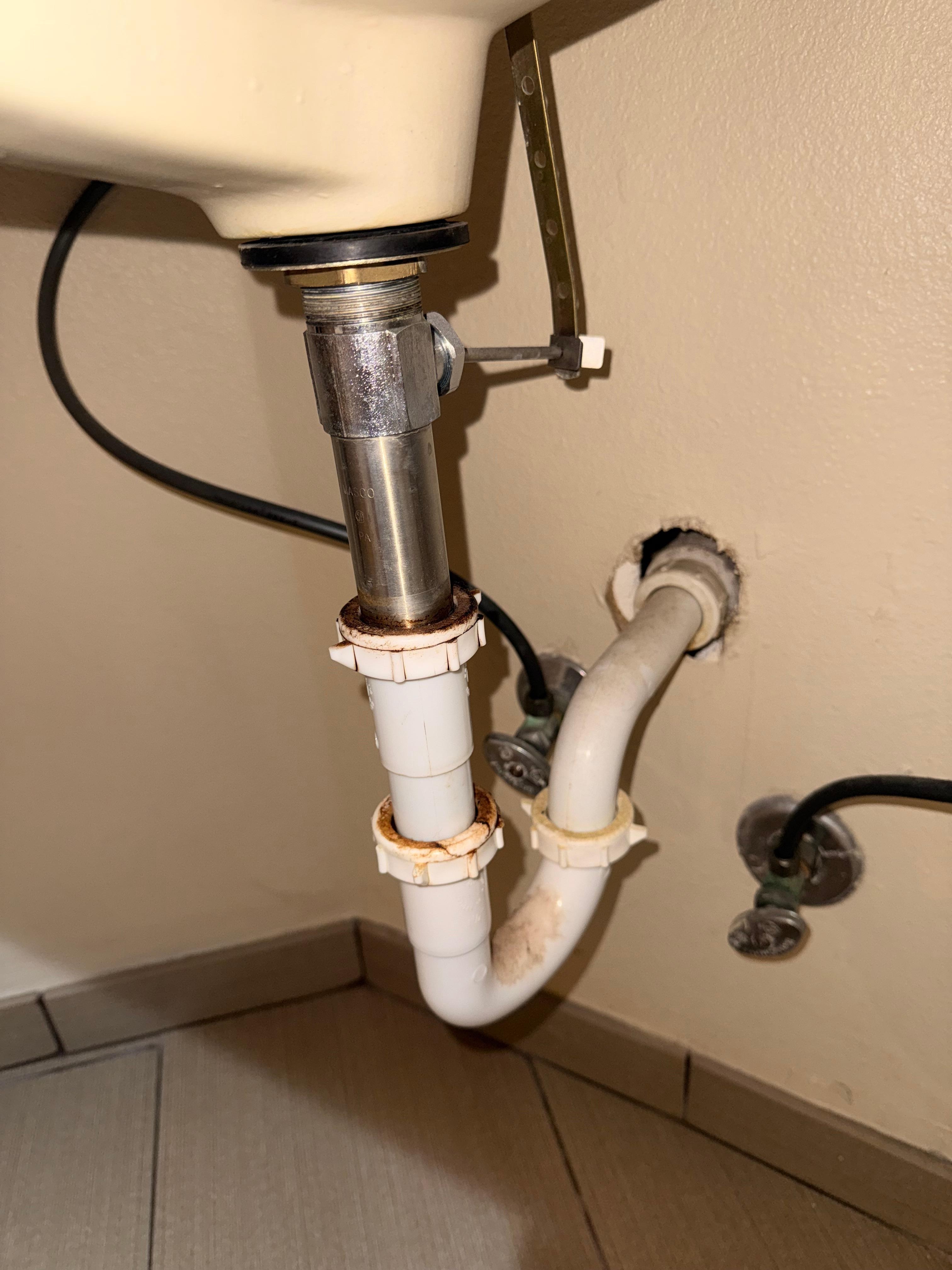 Hole around plumbing drain. Pipes not clean and covered. 