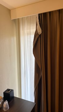 Curtains were partially of their rod.