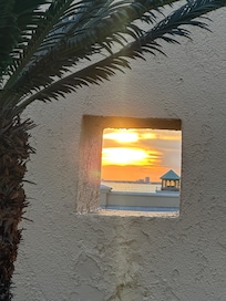 Sunset through the wall on the tanning patio by the Beau Rivage pool