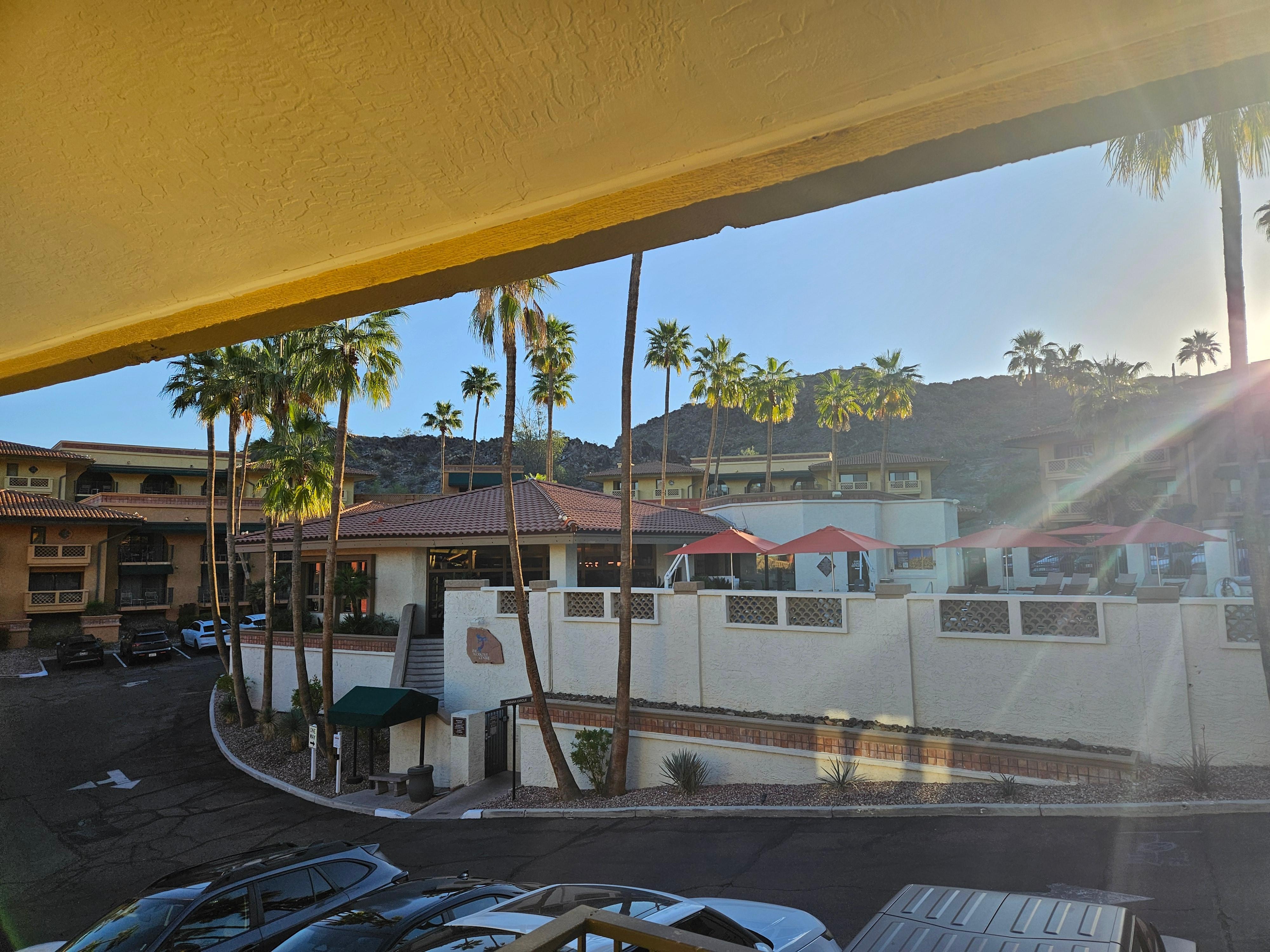 View from room balcony. Building is gym and one of the pools