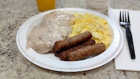 Sausage and eggs breakfast with biscuits and gravy