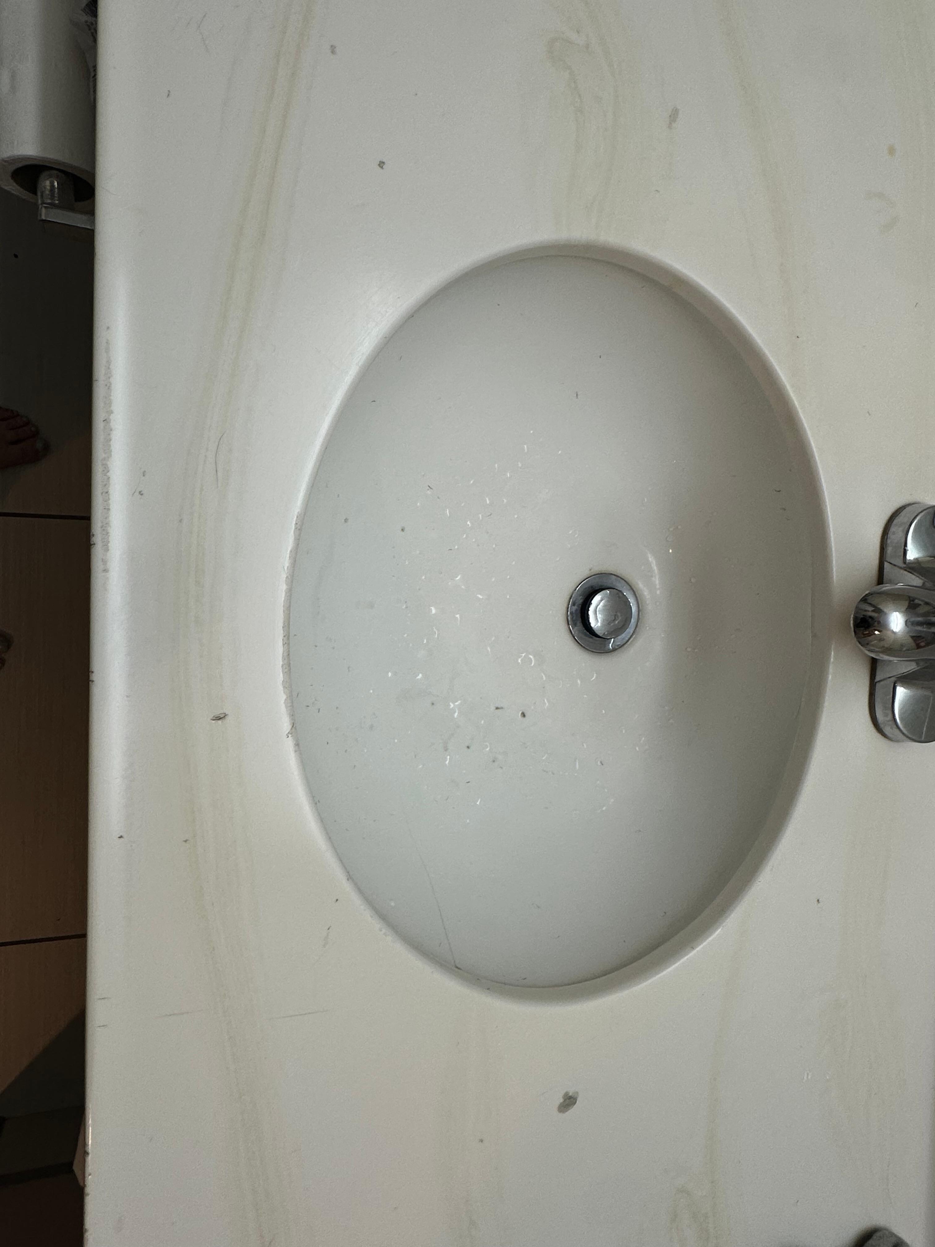 Chips and holes in sink and counter that made it look dirty.