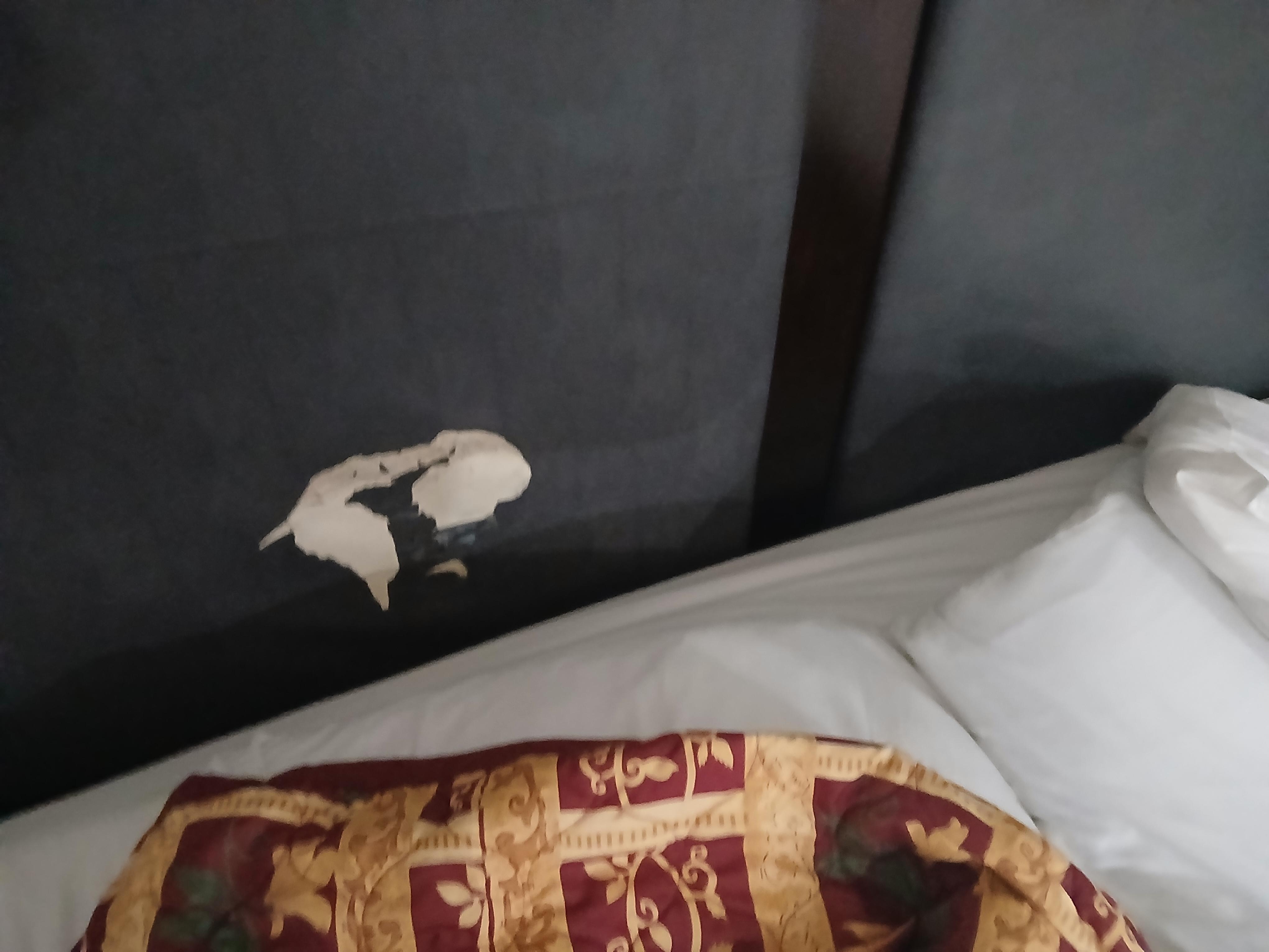 Paint peeling and scratched on the head board of the bed