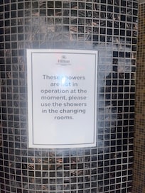 There was at least a sign but you had to go into the changing rooms to use the shower which was a distance away