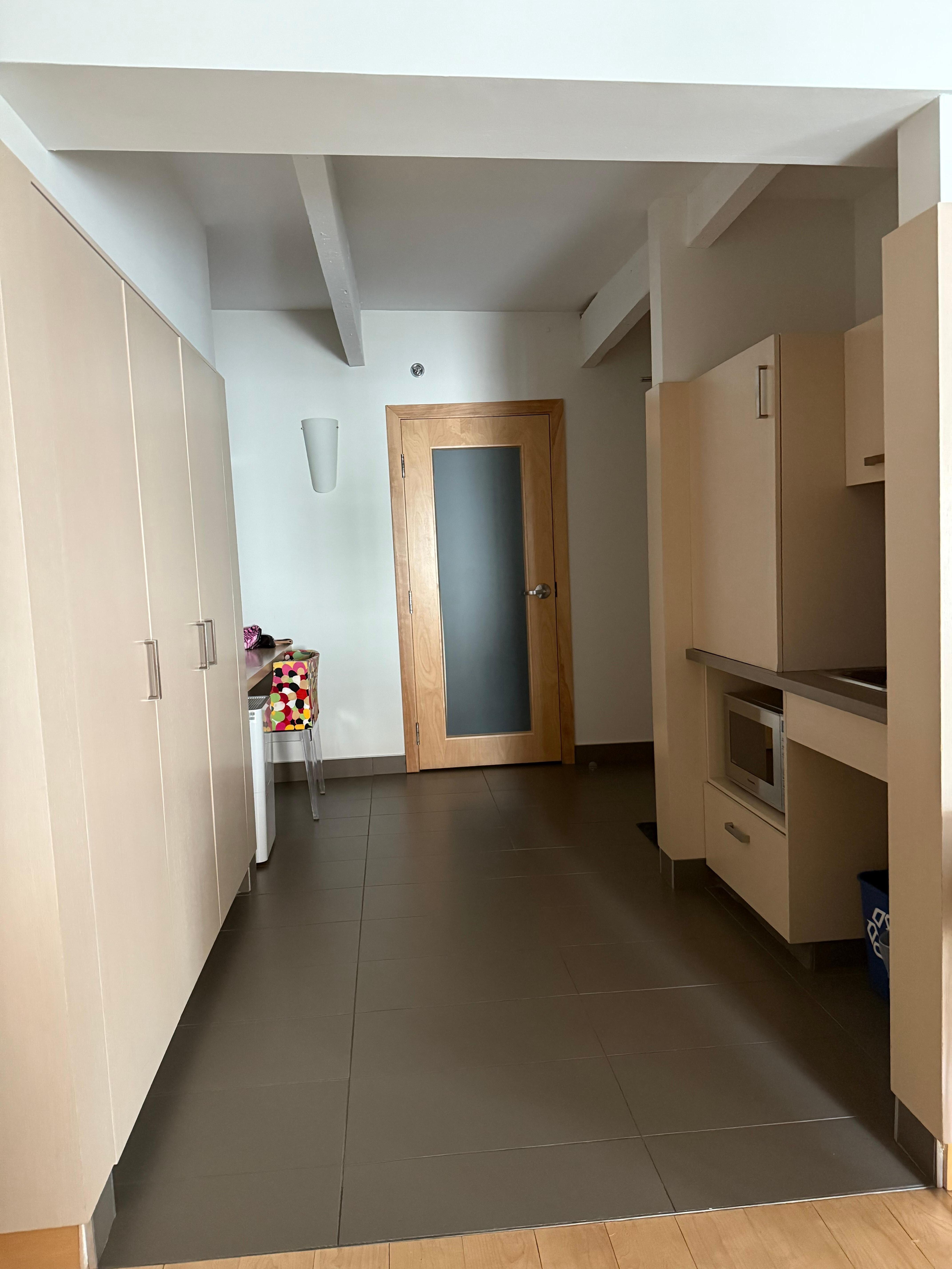 Kitchen /wardrobe/storage area - very spacious bathroom area through door facing you. 