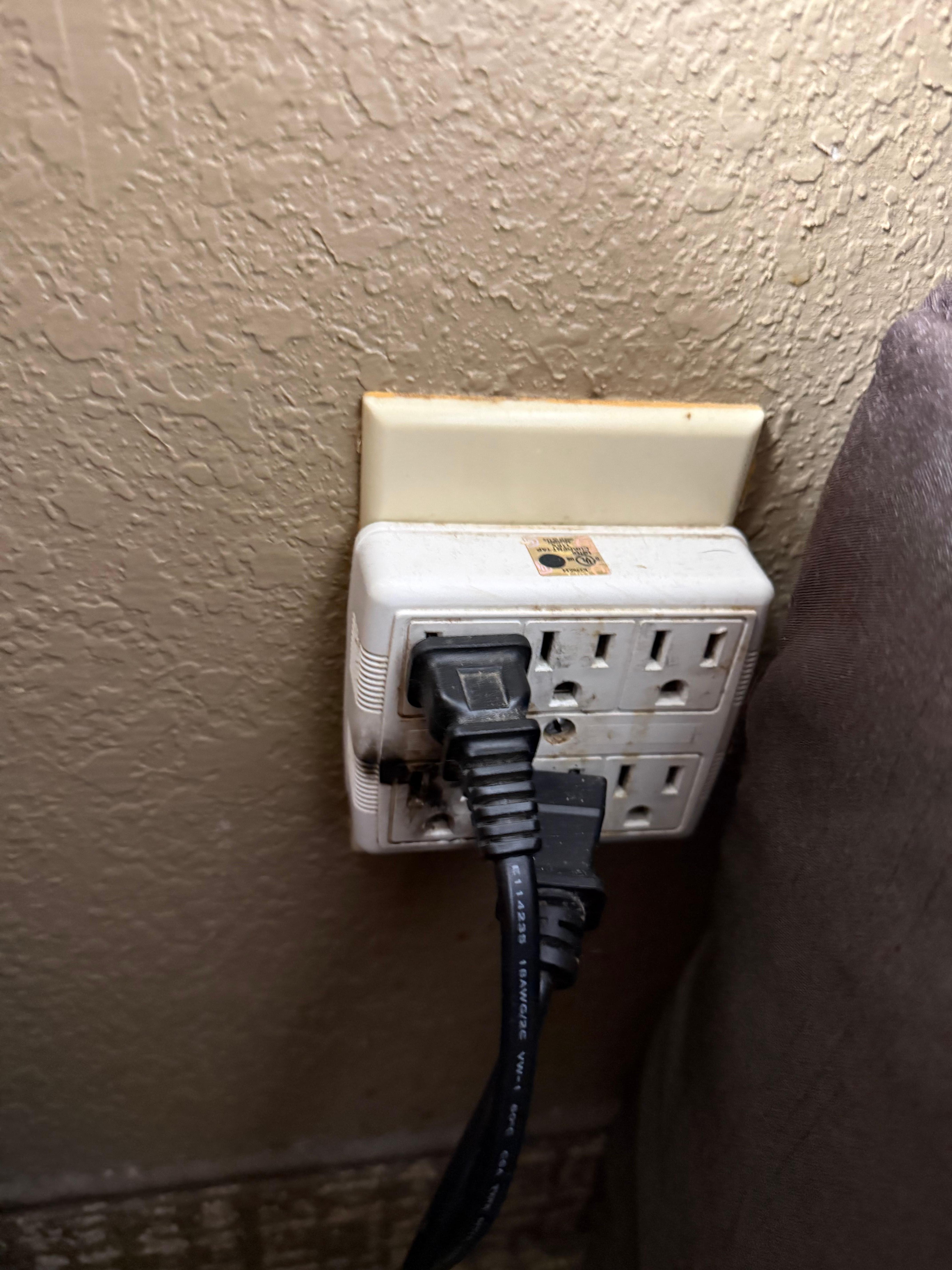 Outlet that looks like it may have been on fire at some point 