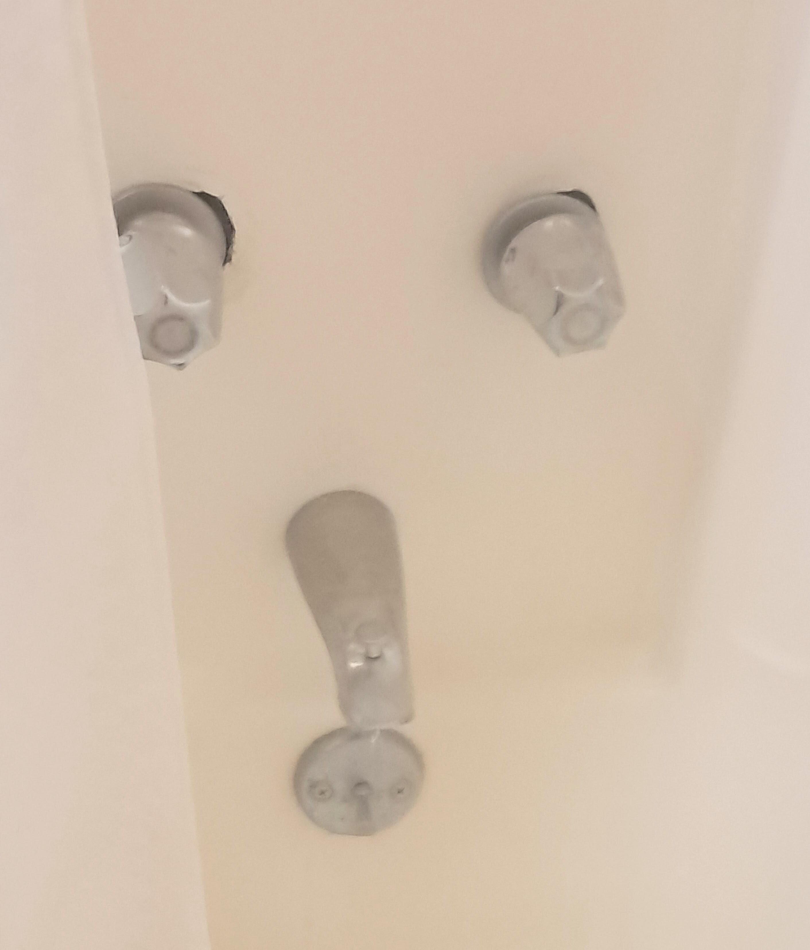 handles and faucet loose like they're about to all off. See holes behind handles.