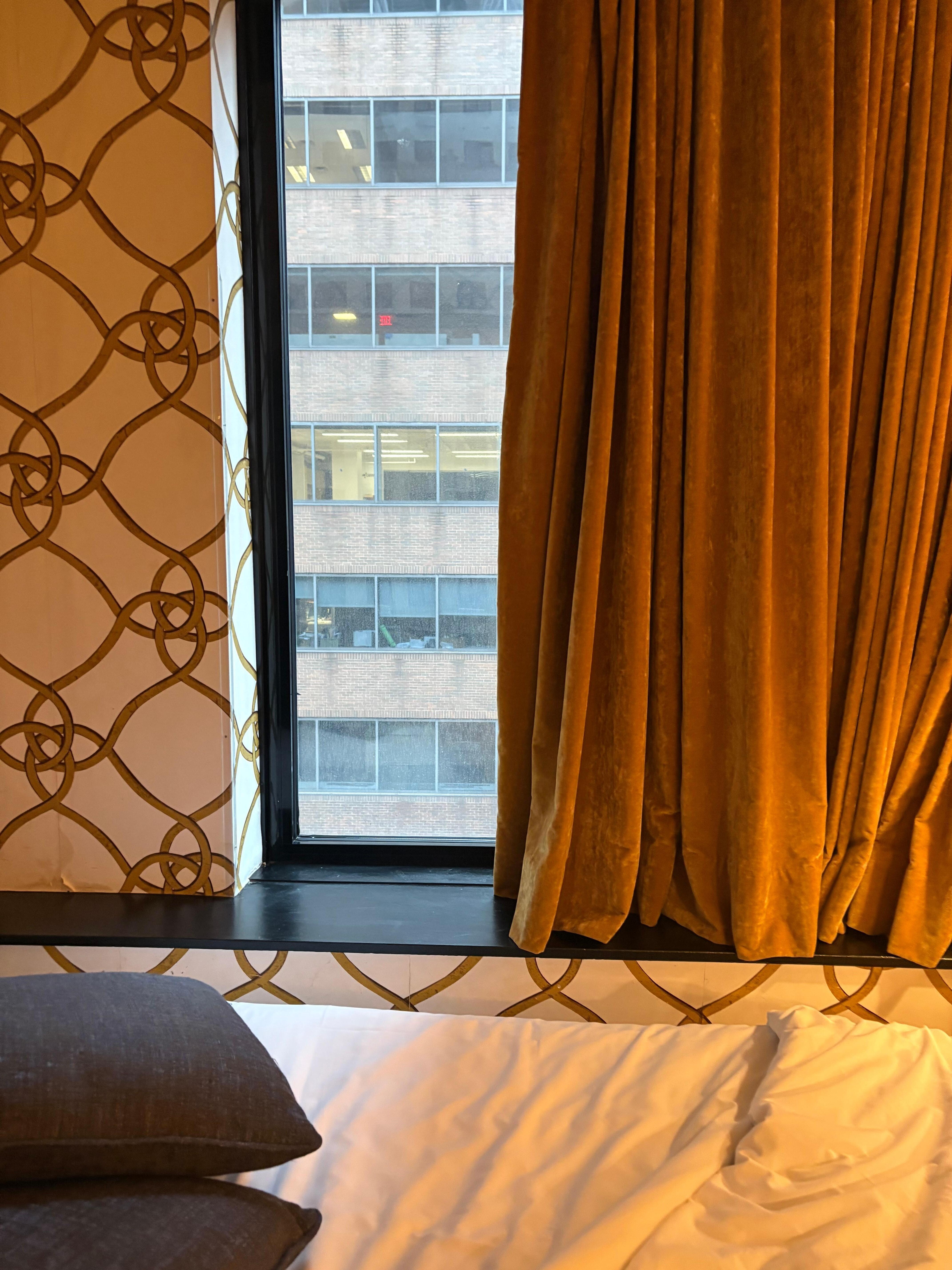 No place to walk between bed and window to close drapes.