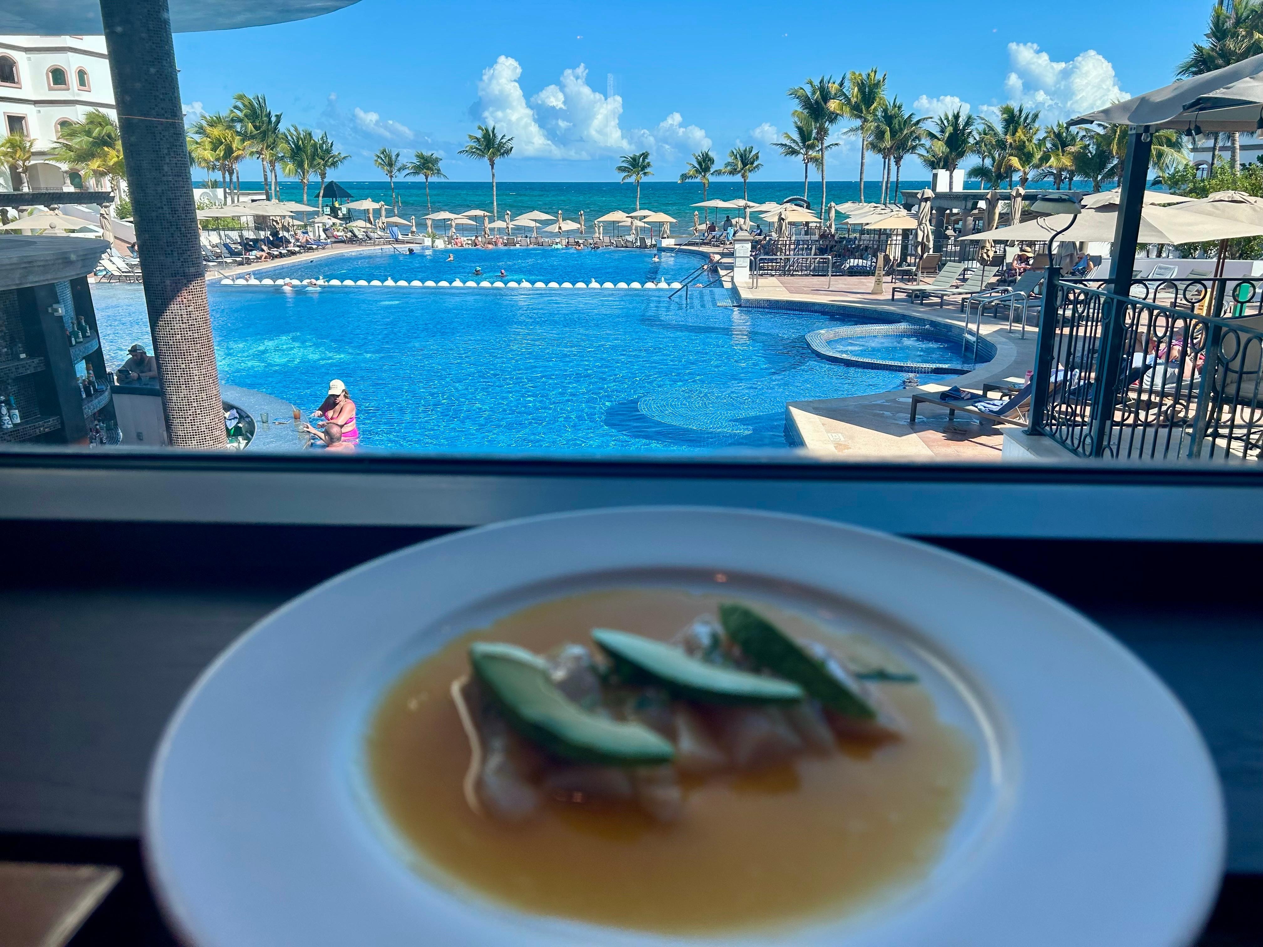 Delicious ceviche with an impressive view over the immense swimming pools.