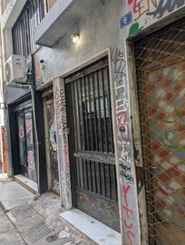 Entry door to the building. It is in an alley where cars cannot drive down.