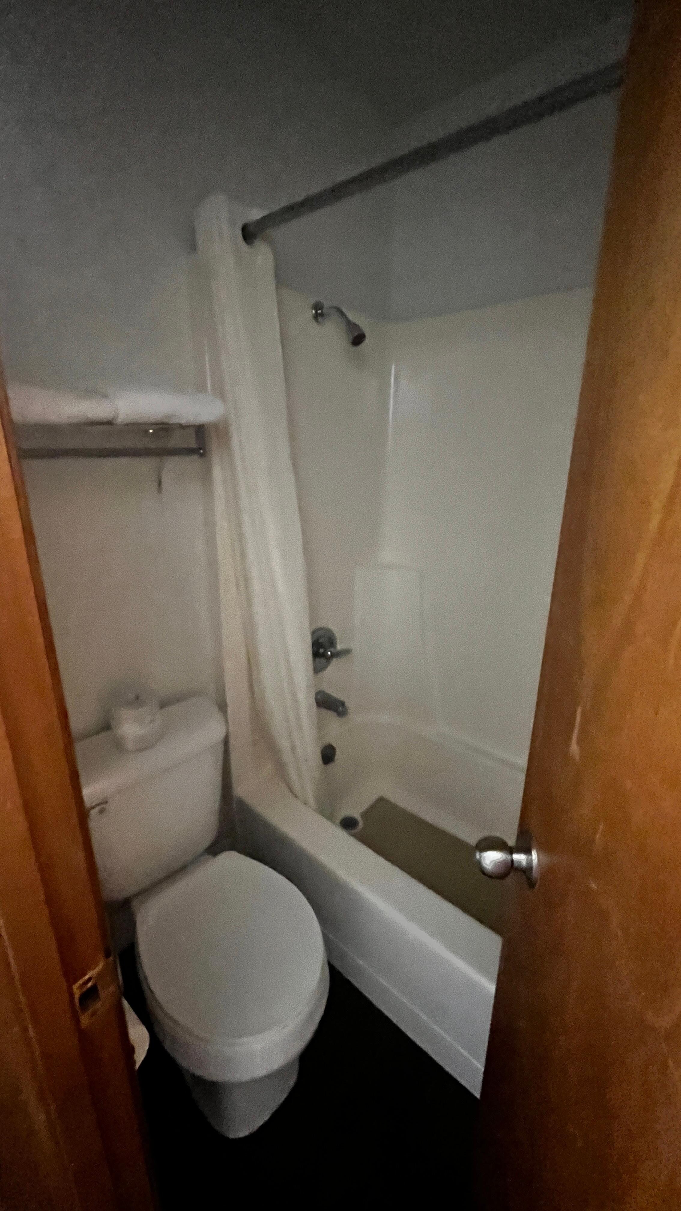 The cramped and gross bathroom, with two completely different lights and vents.