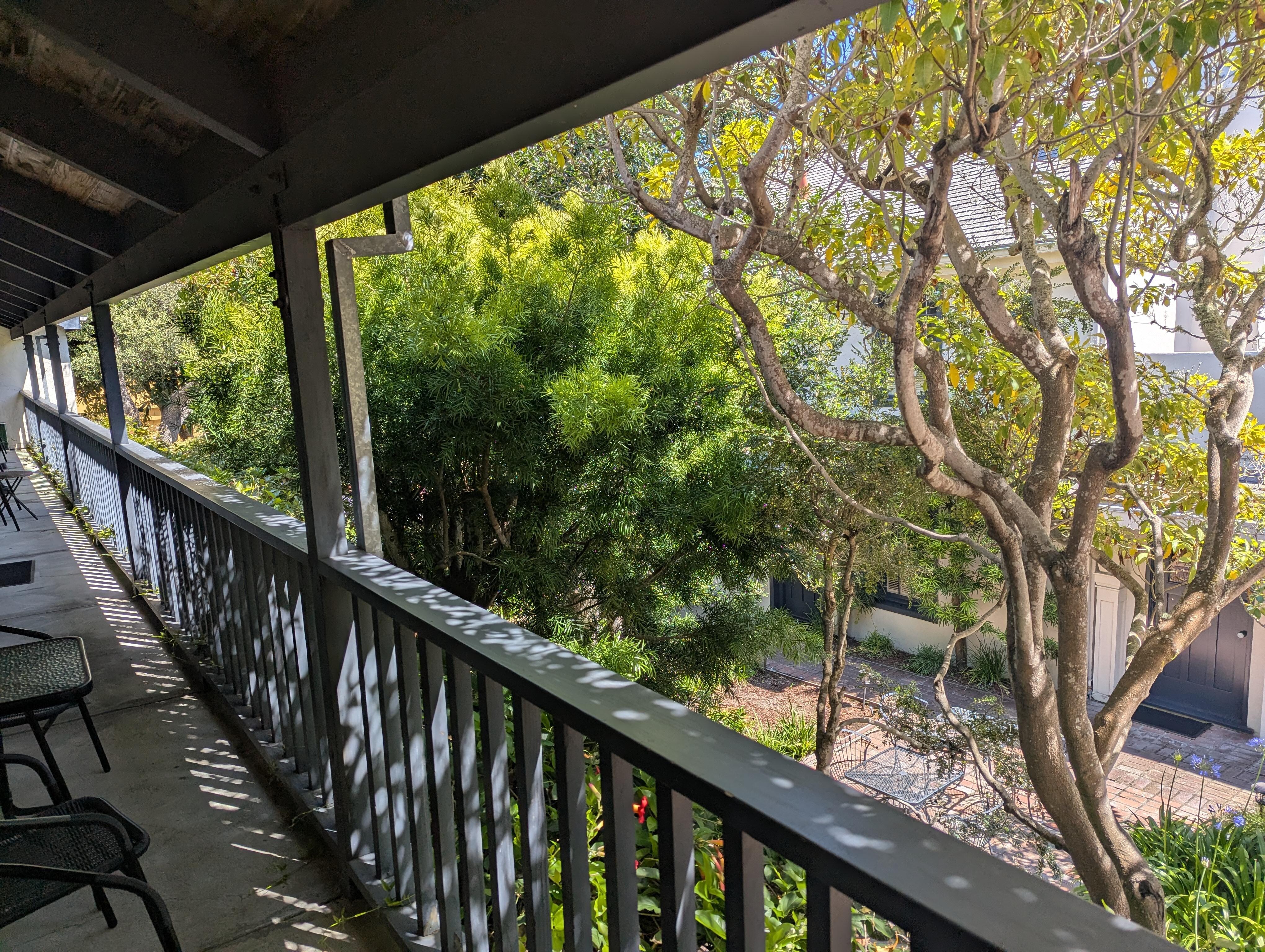 Shady balcony overlooking courtyard.