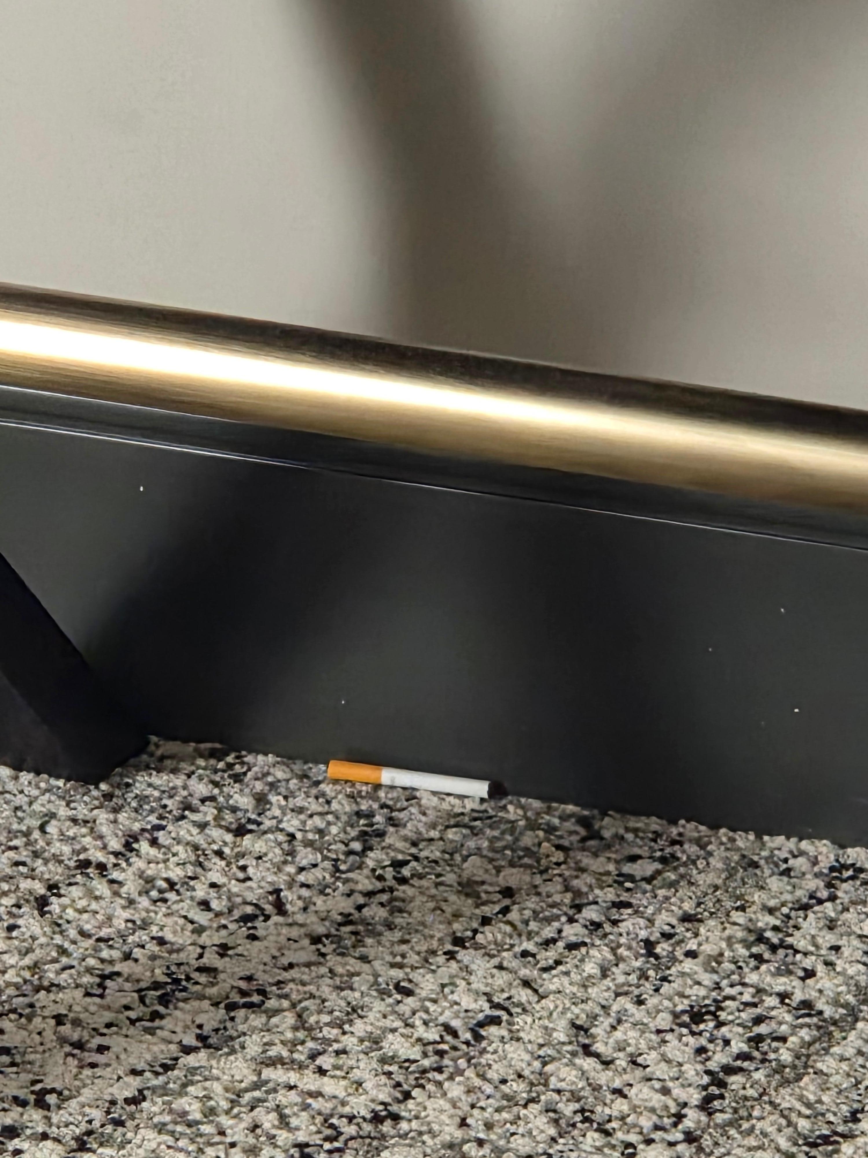 Cigarette on the floor, non smoking room. 