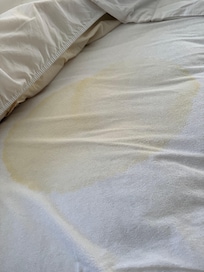 The mattress pad had huge fluid stains they covered with fitted sheets