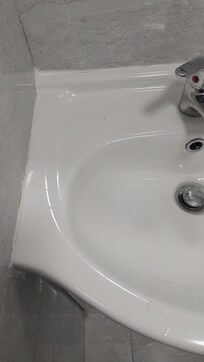 stains (blood?) and hair in sink. Sink also explosively and intermittently spat hot water