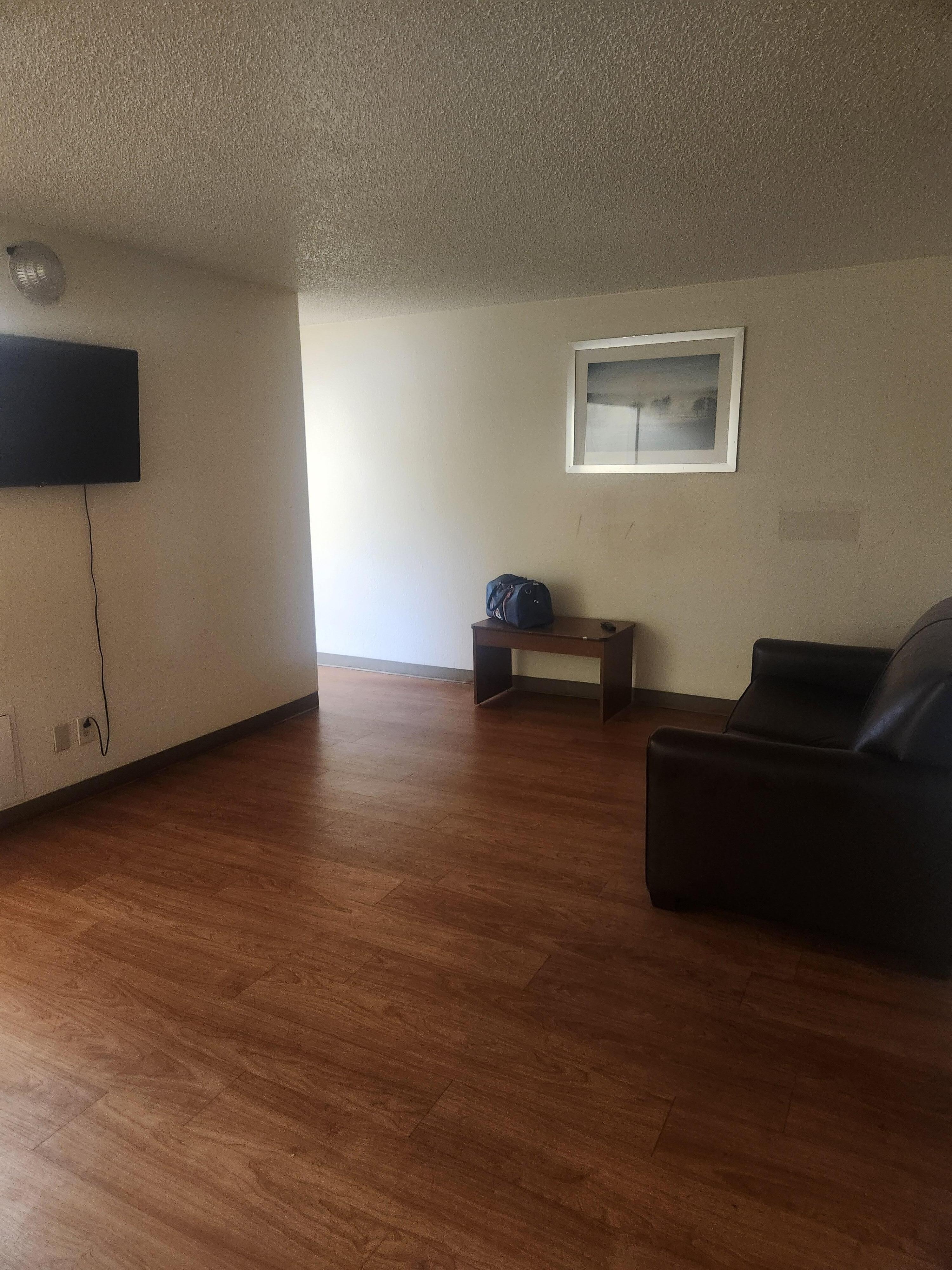 Living room, no carpet, uncomfortable couch