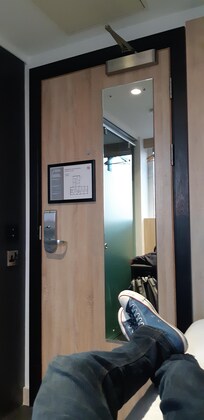 Main door. The front handle can only be pushed down with the keycard pressed to the sensor, but the door features a deadbolt for privacy and extra security.