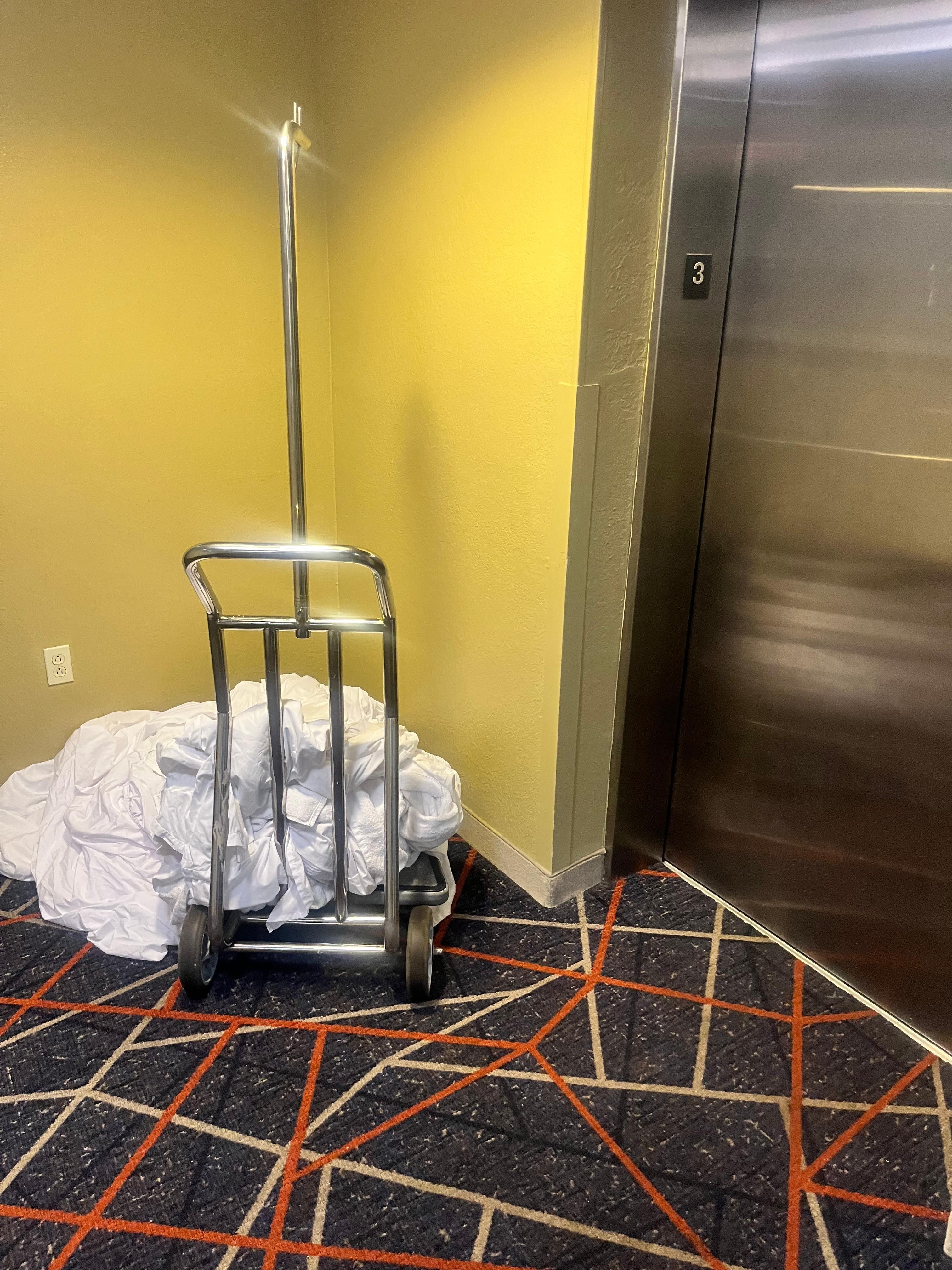 Sheets in hallway near elevator at 3rd floor