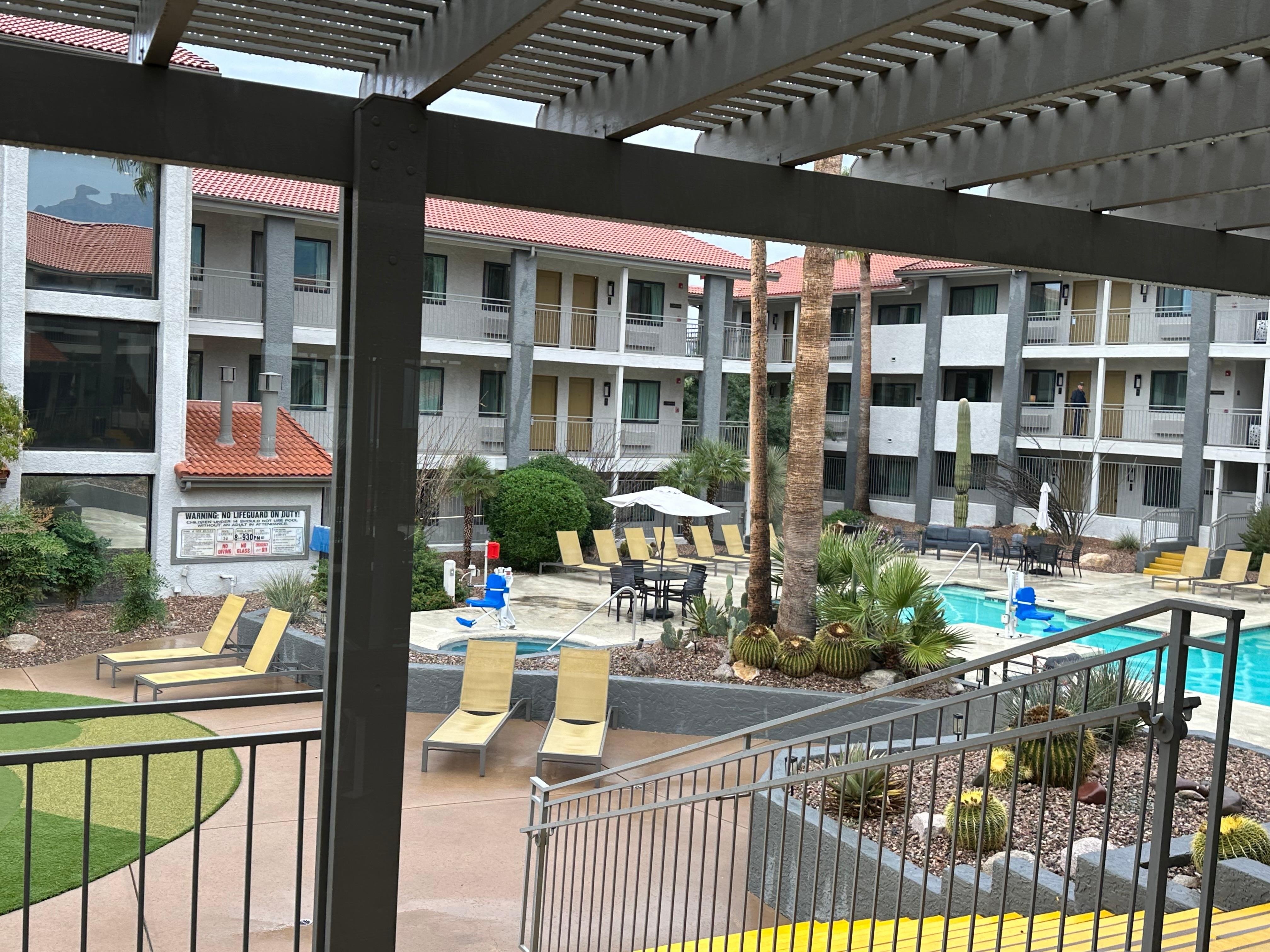 Pool and hot tub with lounge chairs