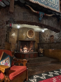 Fireplace kept blazing by the cowboy in the black hat