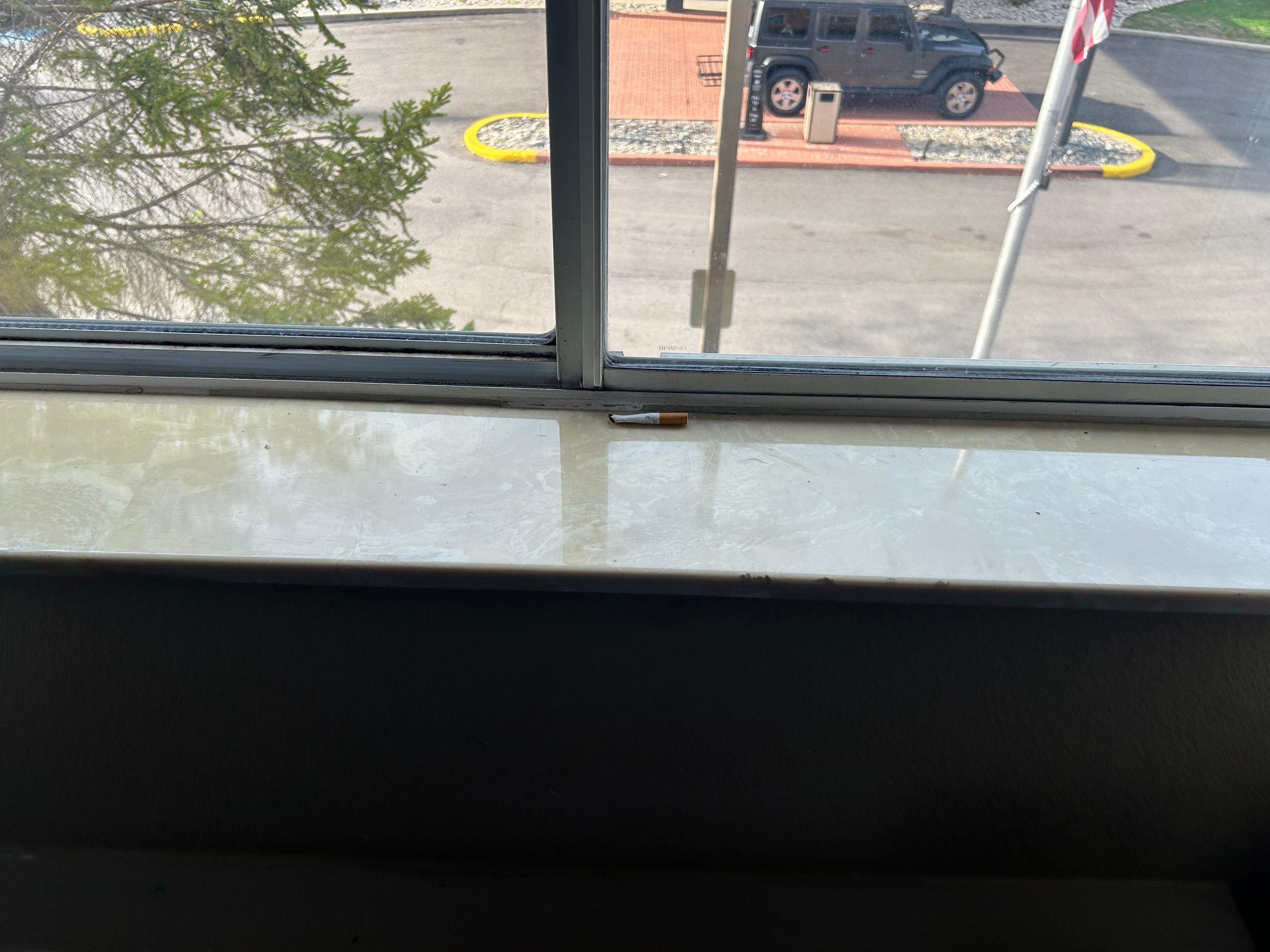 Cigarette on the window sill.  Supposedly a 100% smoke free hotel.